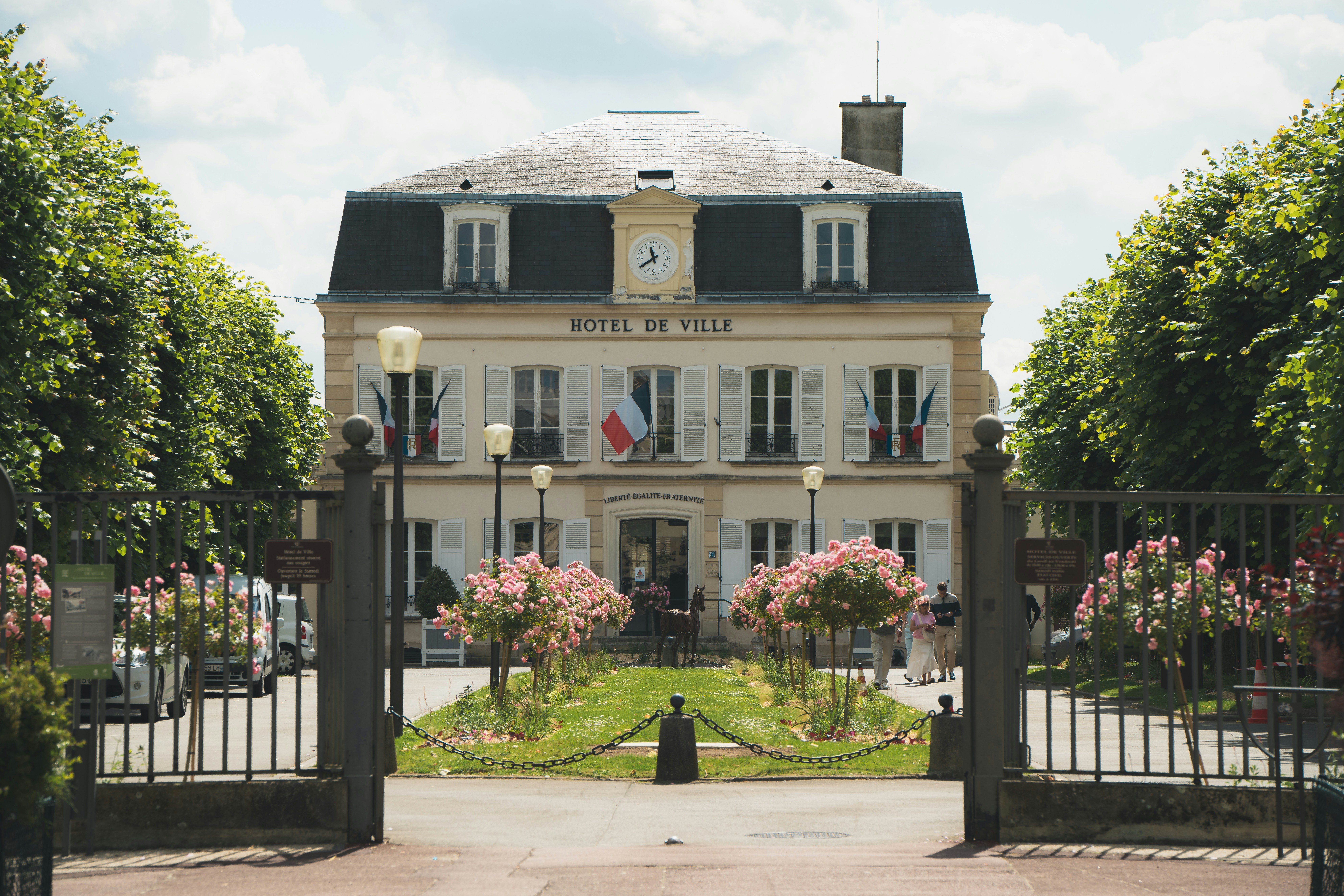A large building with a gate in front of it photo – Free Building Image ...
