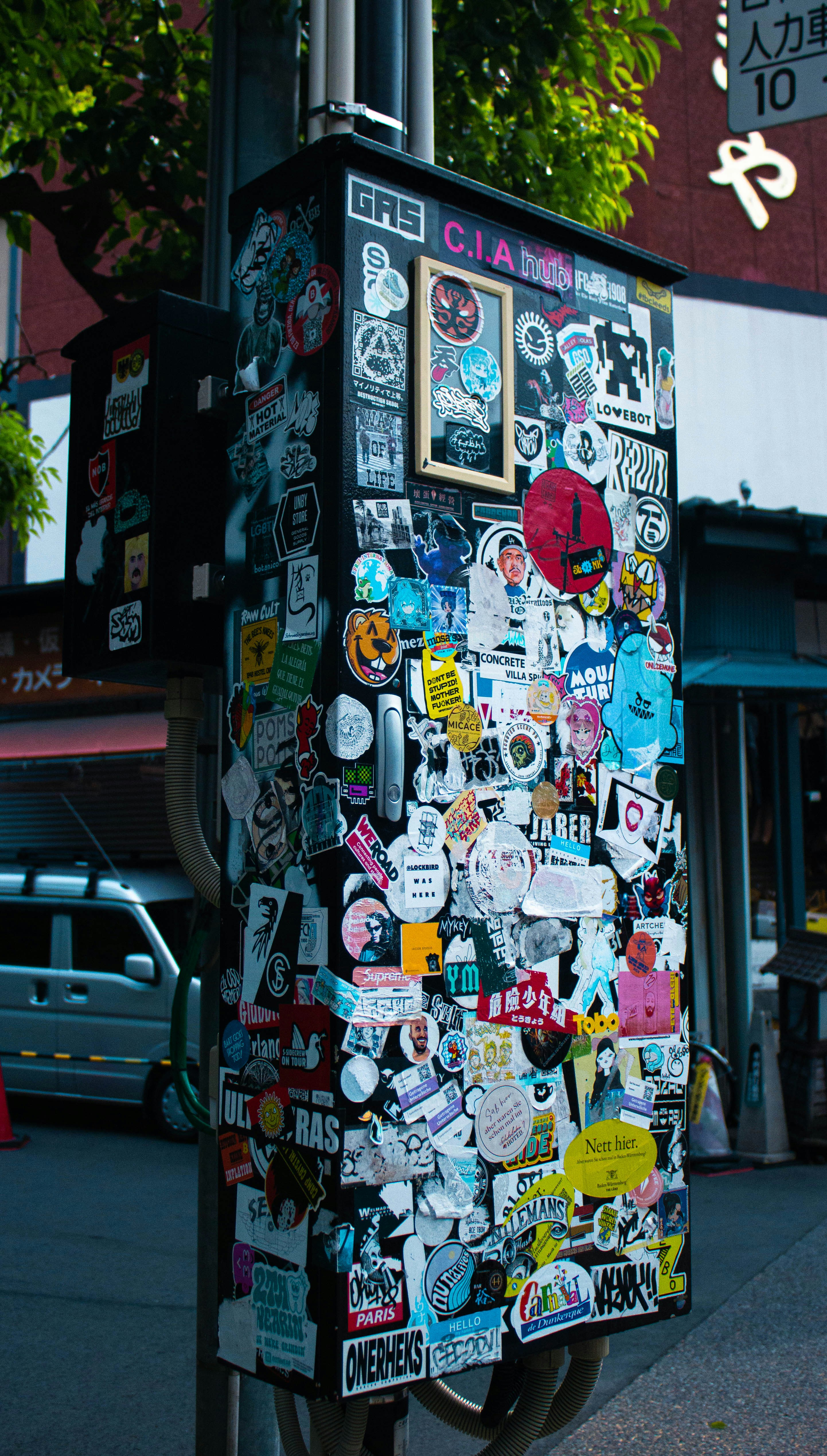 A pole with a bunch of stickers on it photo – Free Sticker Image on ...