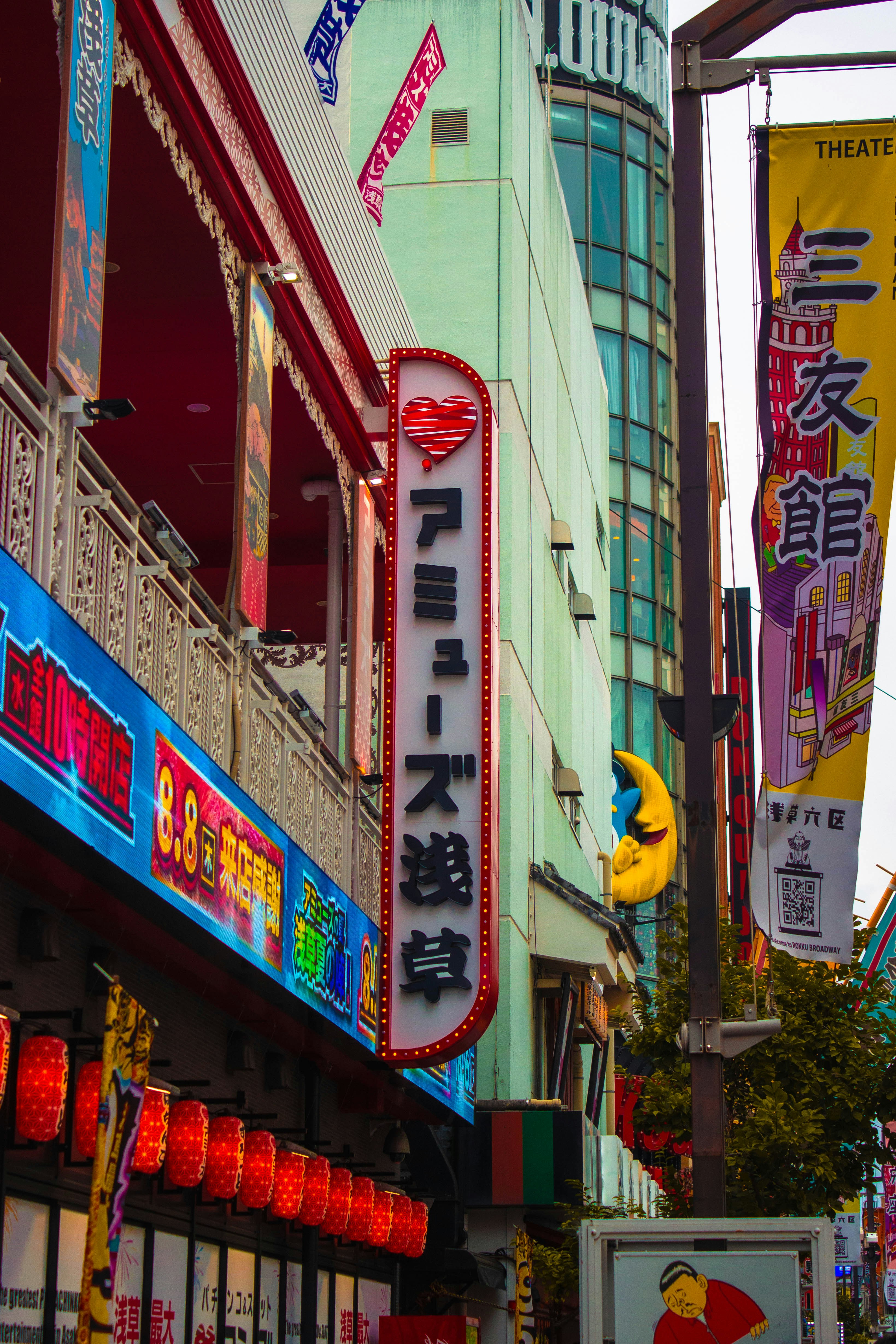 Vertical Neon Heart Sign Illuminates a Colorful Arcade Street