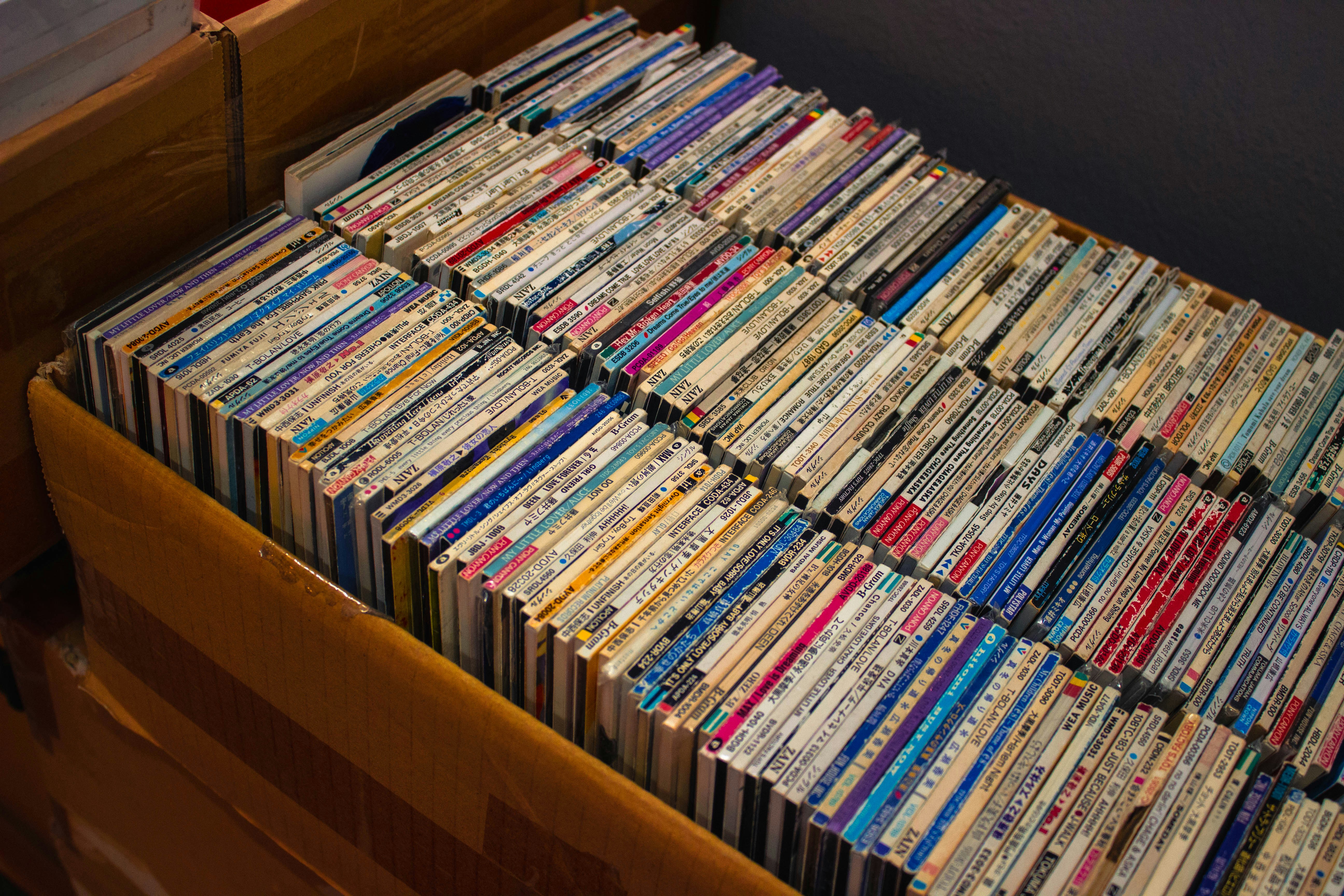 A bunch of cds are stacked on top of each other photo – Free Book Image ...