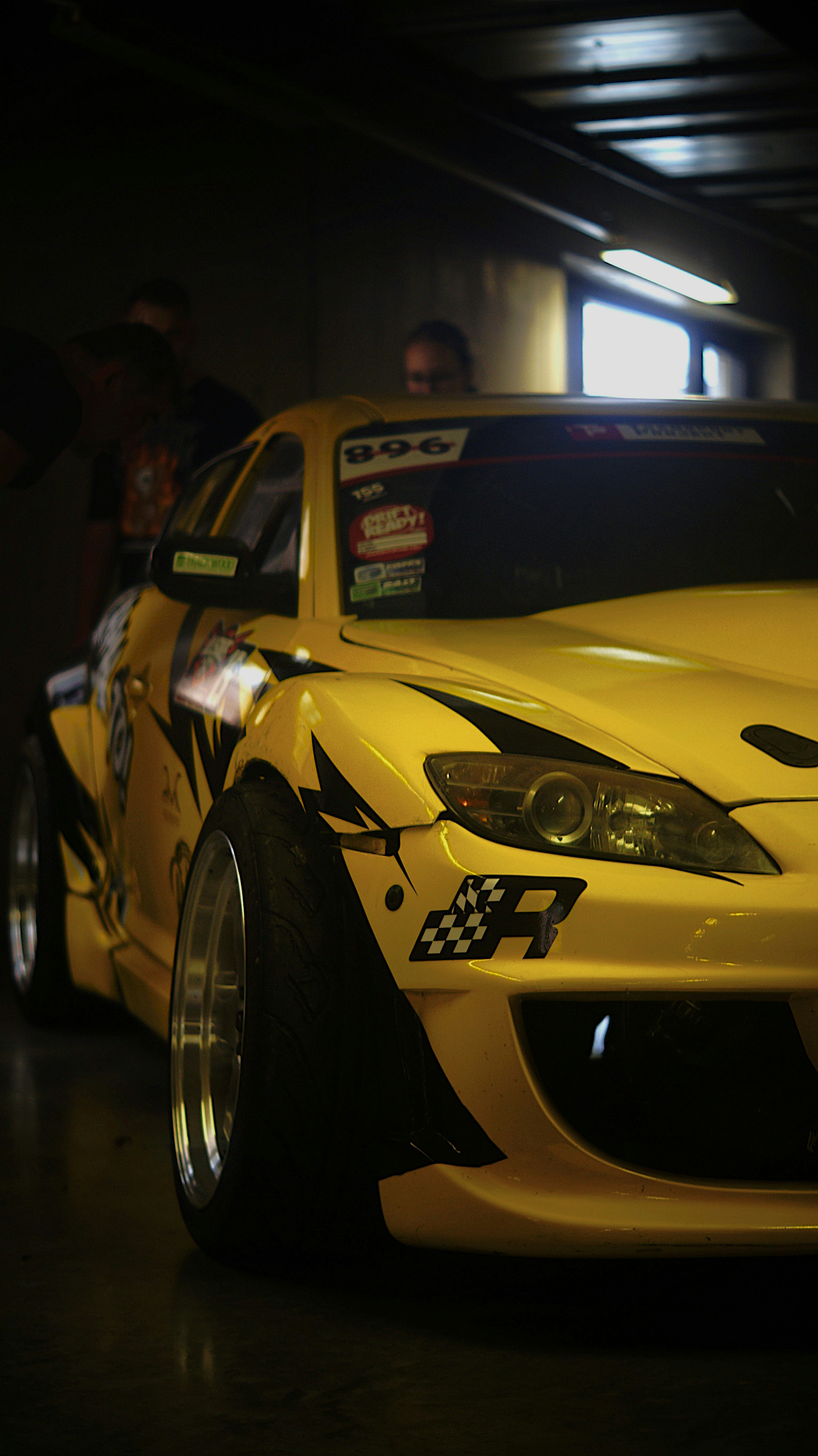 Yellow Racer in the Dim Garage: Front-Quarter Power Amid Shadows