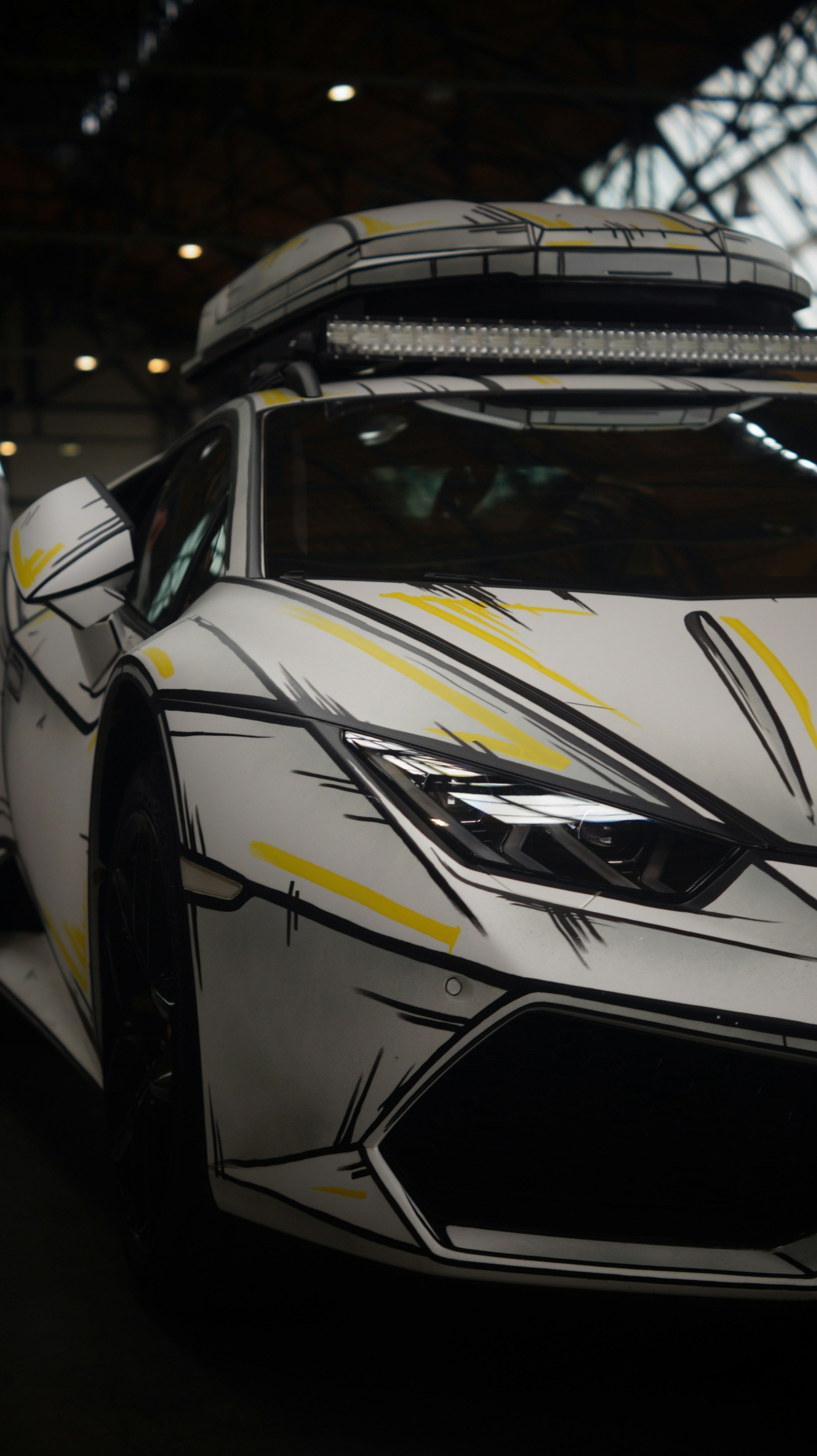 White Lightning: A Graphic-Wrapped Hypercar Halts in a Dim Showroom