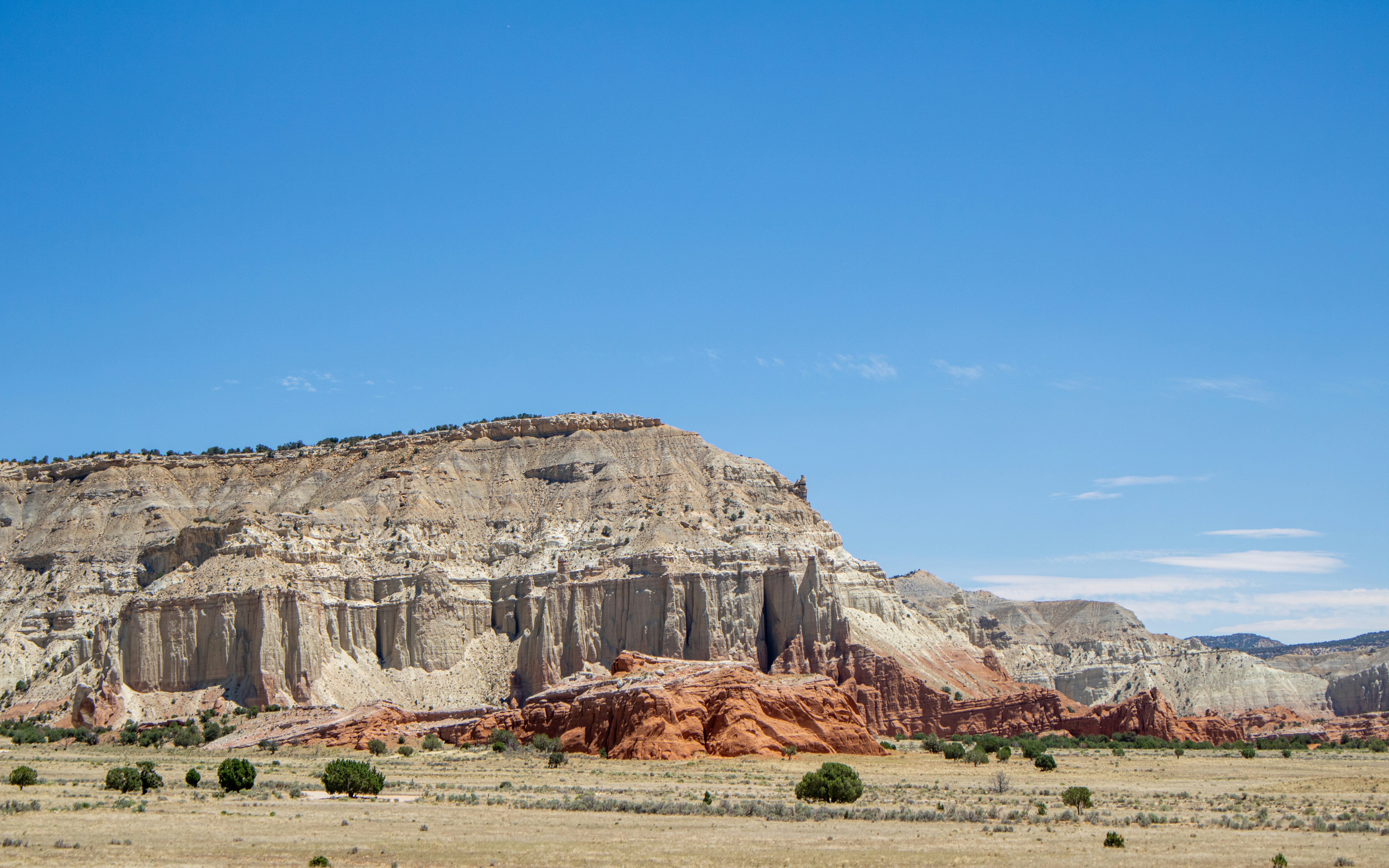 A large rock formation in the middle of a desert photo – Free ...