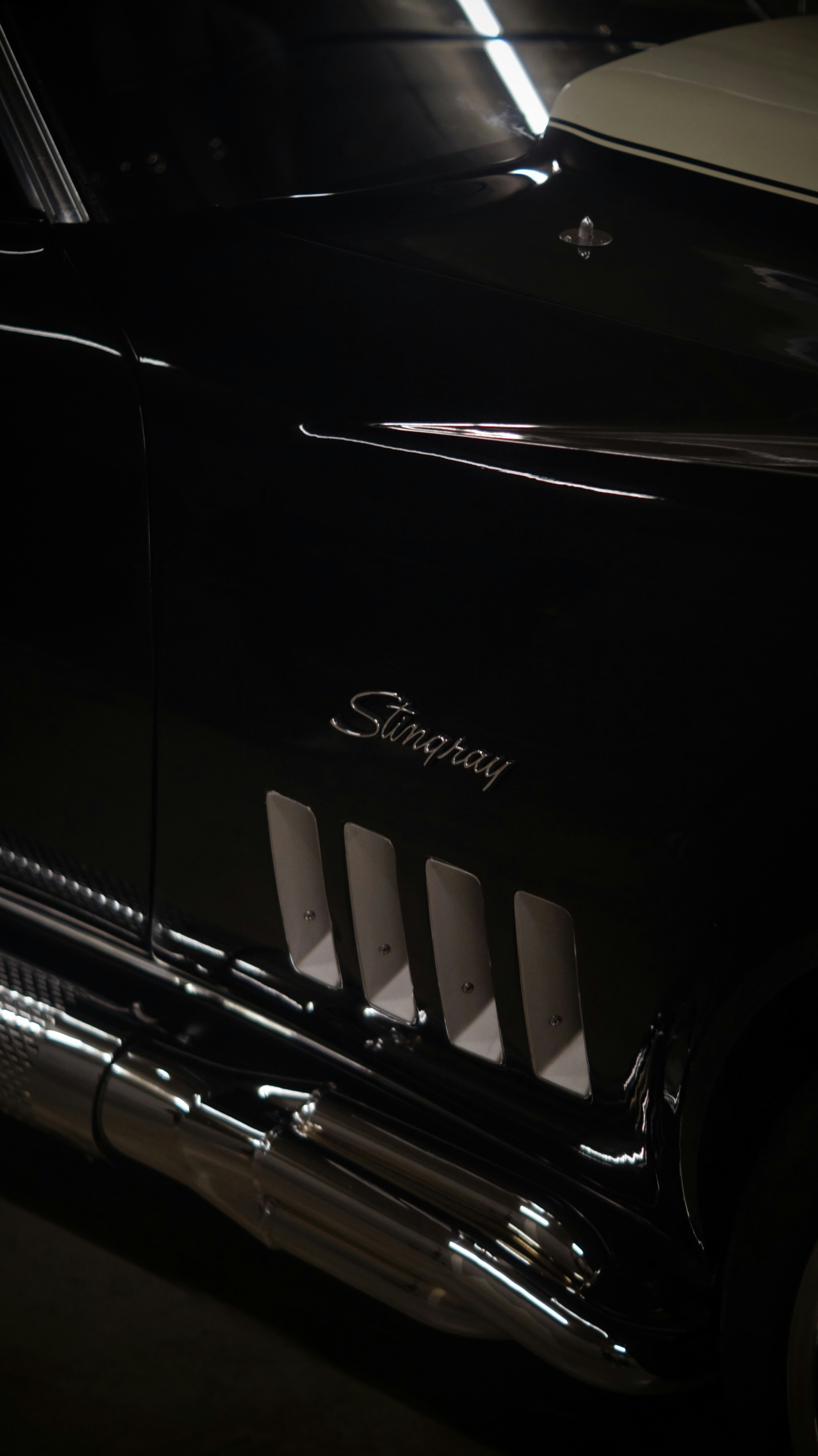 Sleek midnight coupe: chrome accents and signature fins