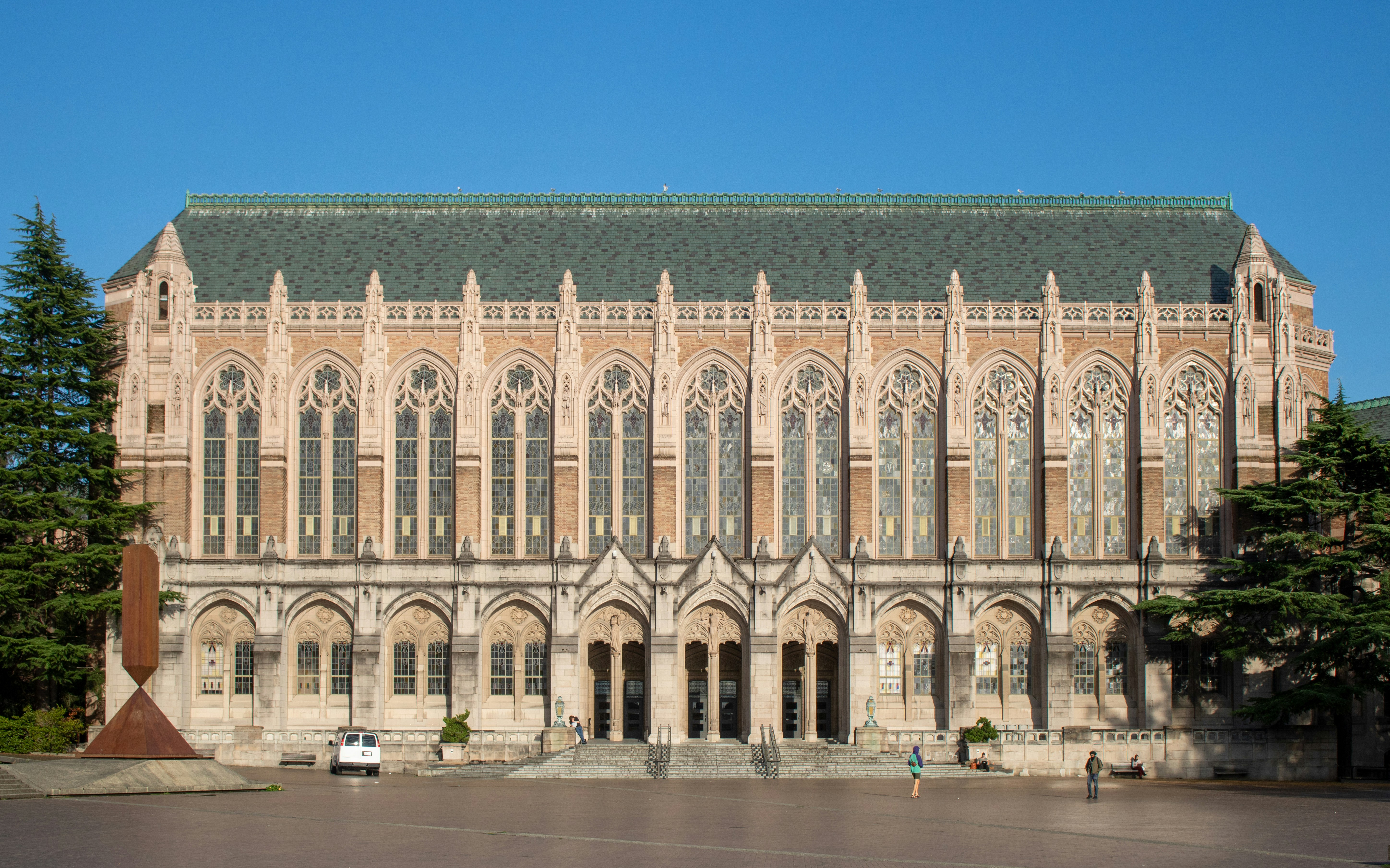 Limestone Symmetry: Sunlit Gothic Facade in a Quiet Plaza
