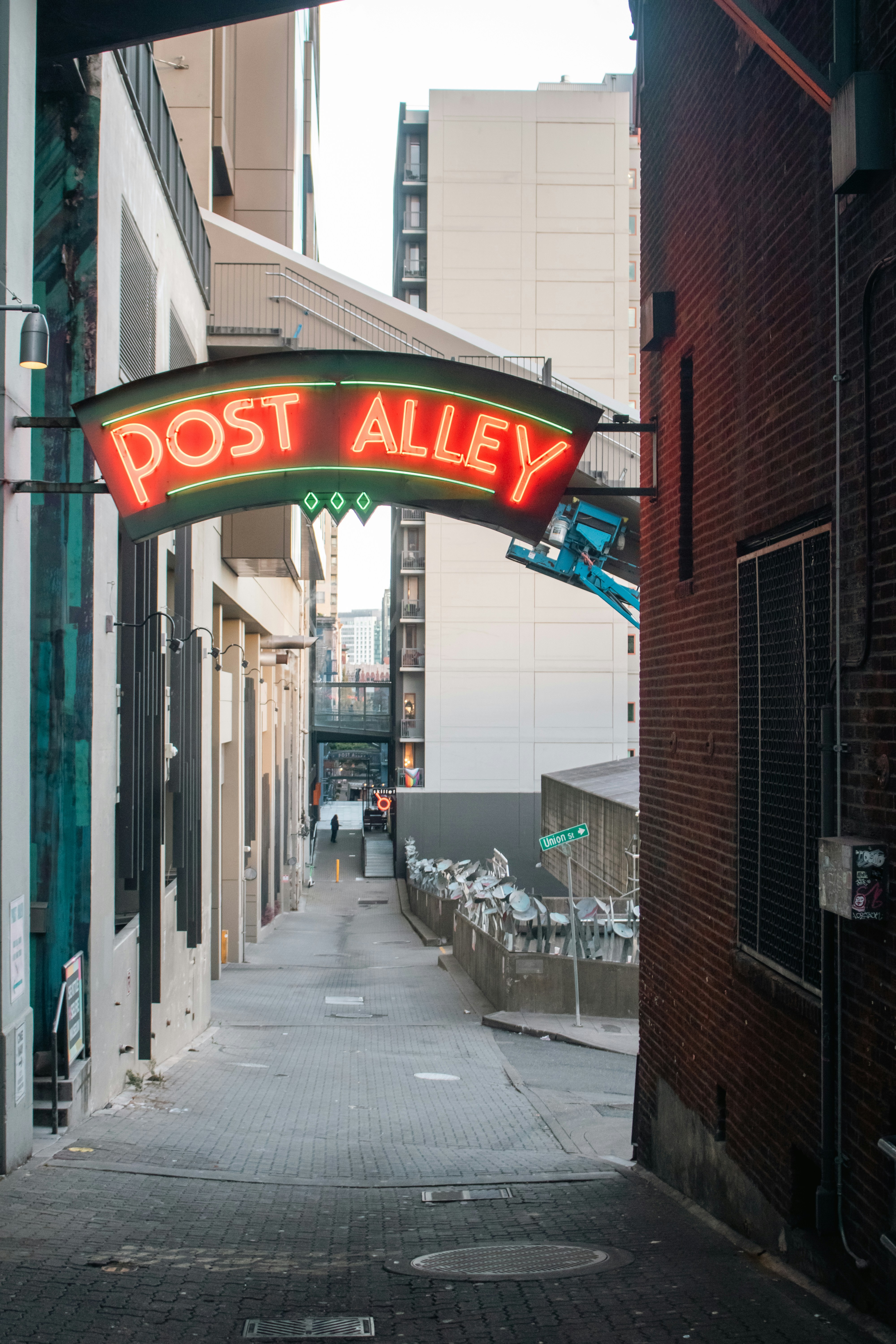 Neon Gateway: Post Alley Arch Frames a Quiet Urban Path