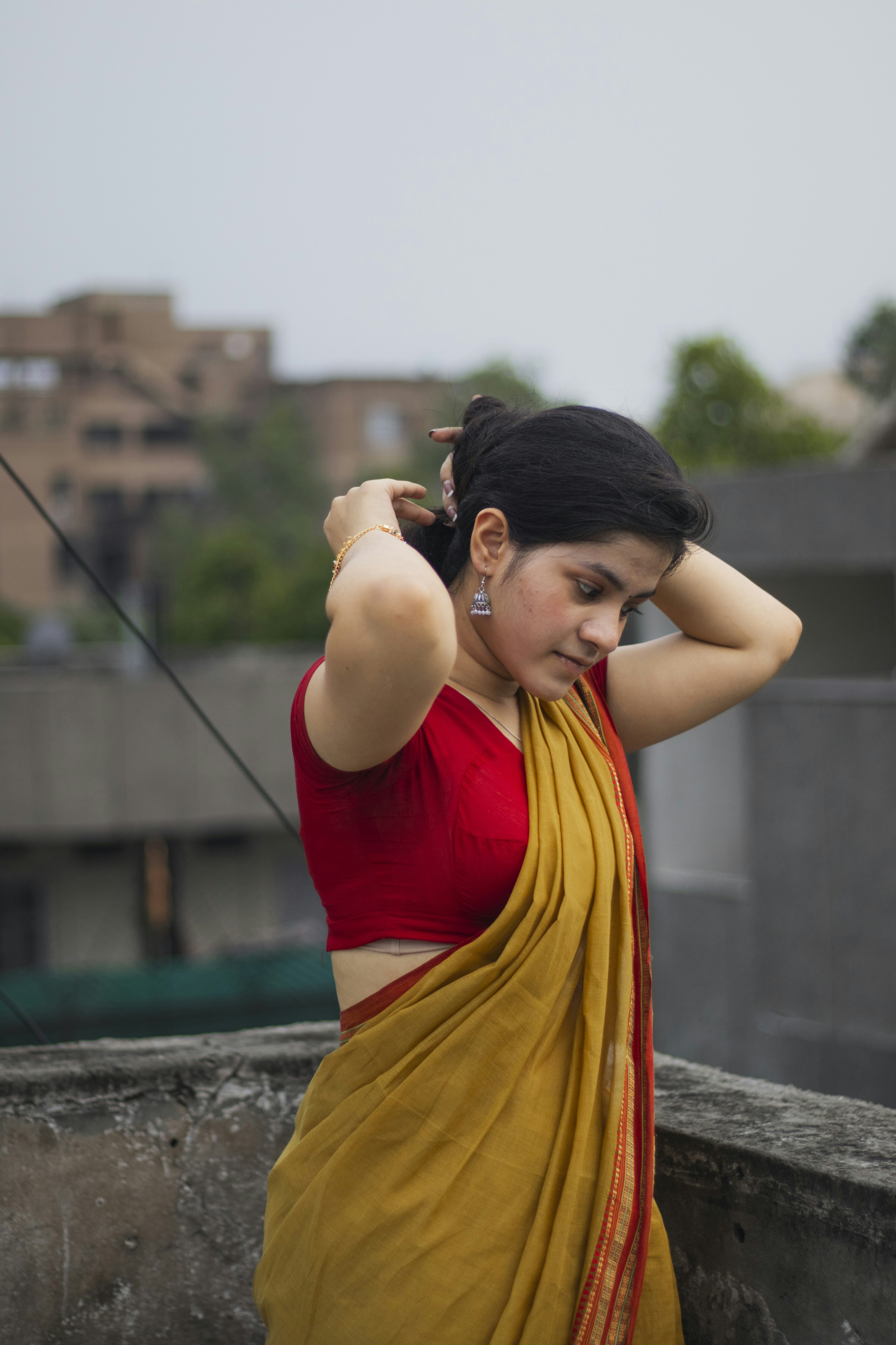 A woman in a red and yellow sari