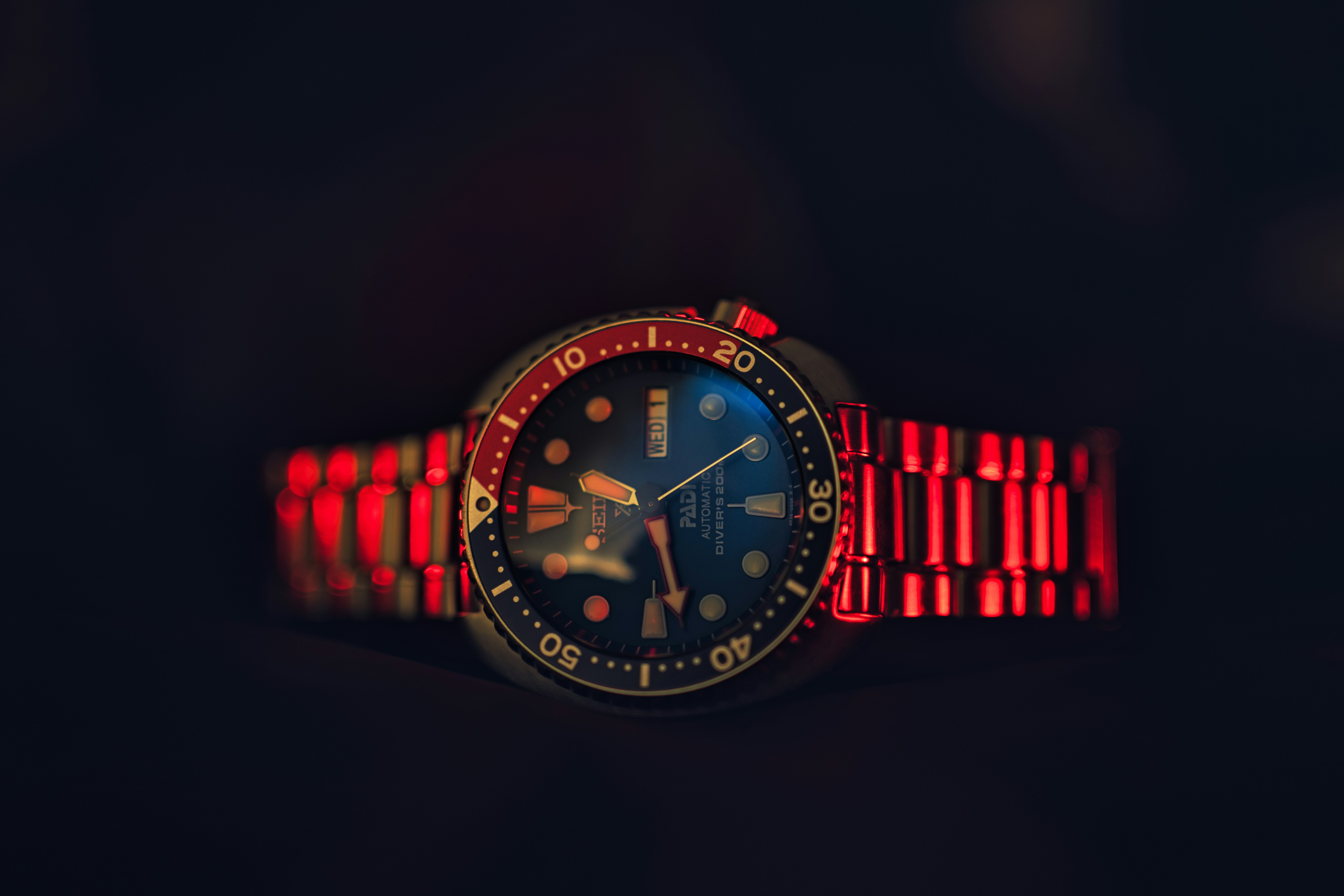 Nocturnal Diver: Blue Dial Surrounded by Red Metal in the Dark