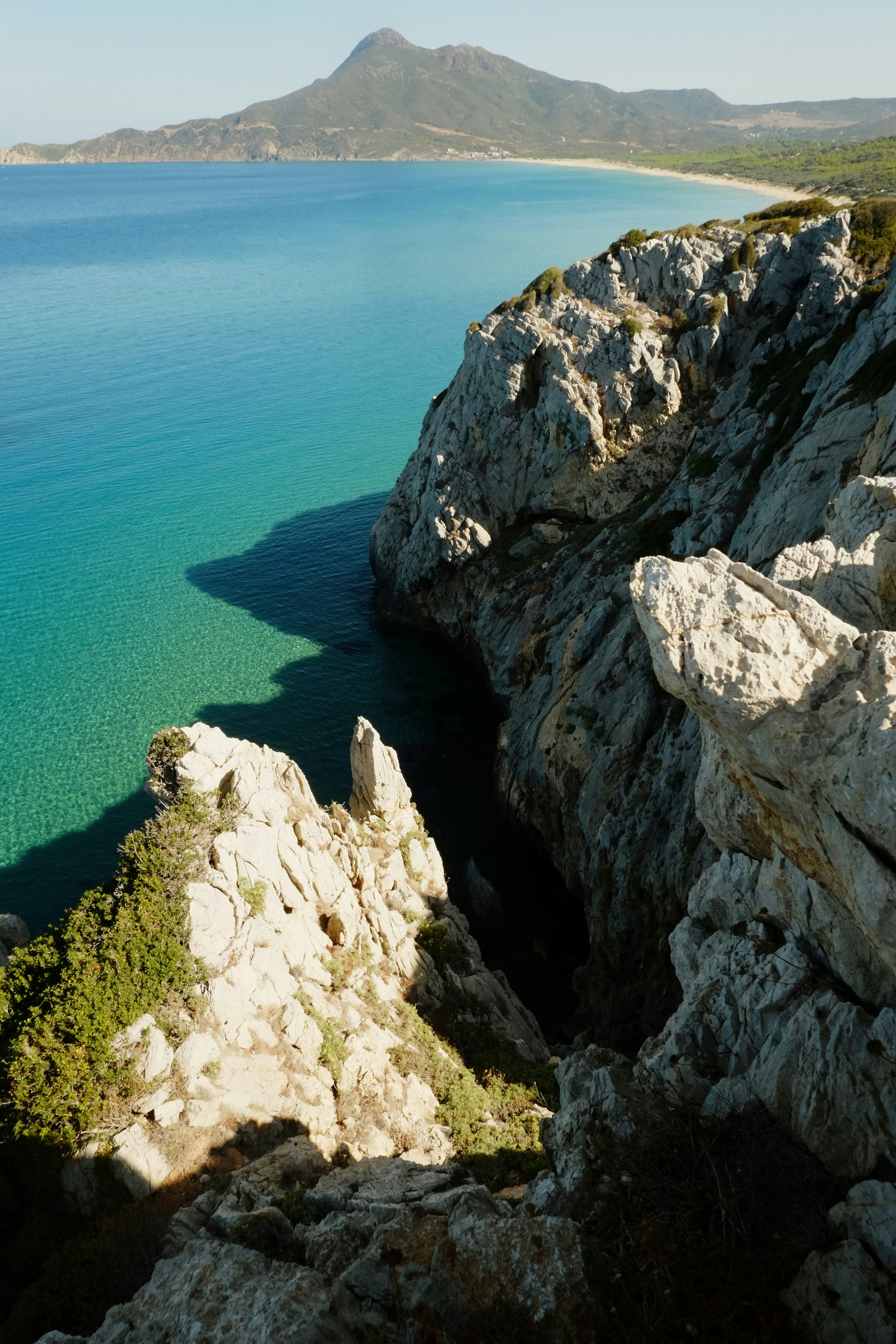 A large body of water surrounded by rocks photo – Free Nature Image on ...
