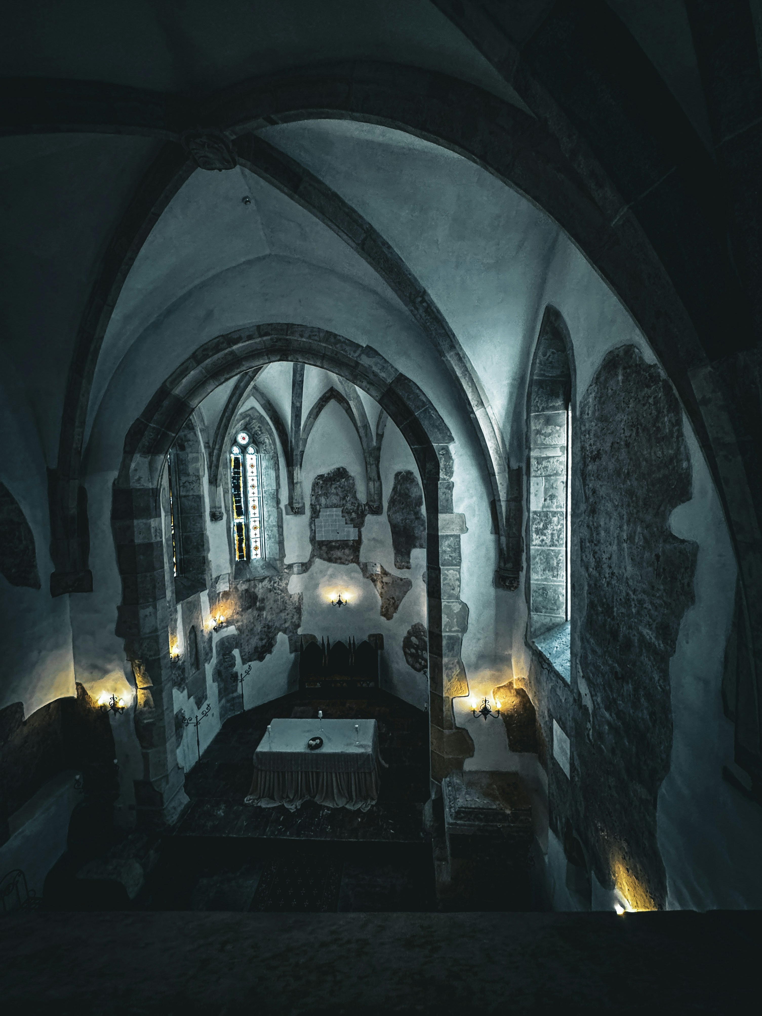 A dimly lit room with a table in the middle photo – Free Building Image ...