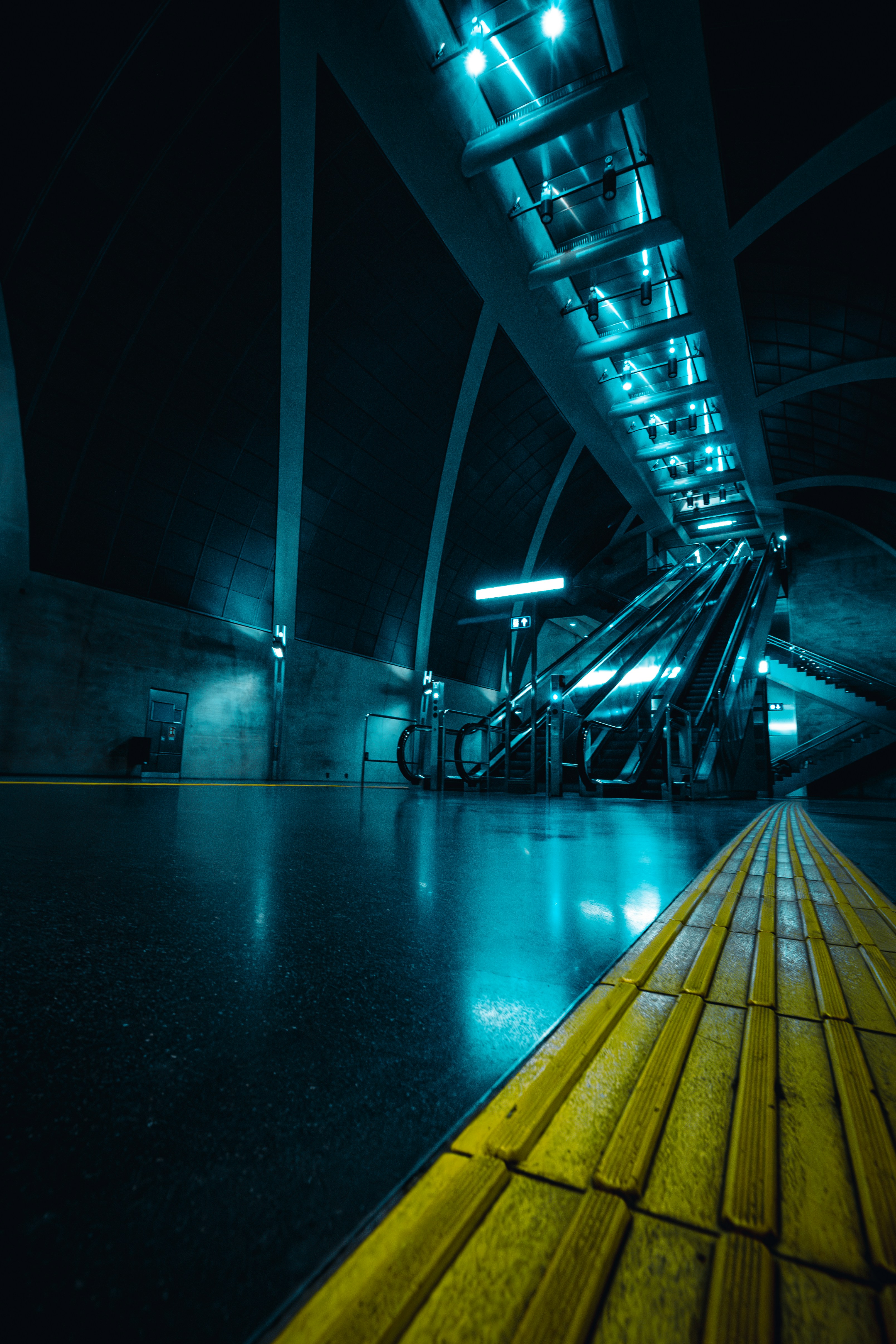 A yellow line on the floor of a subway station photo – Free ...