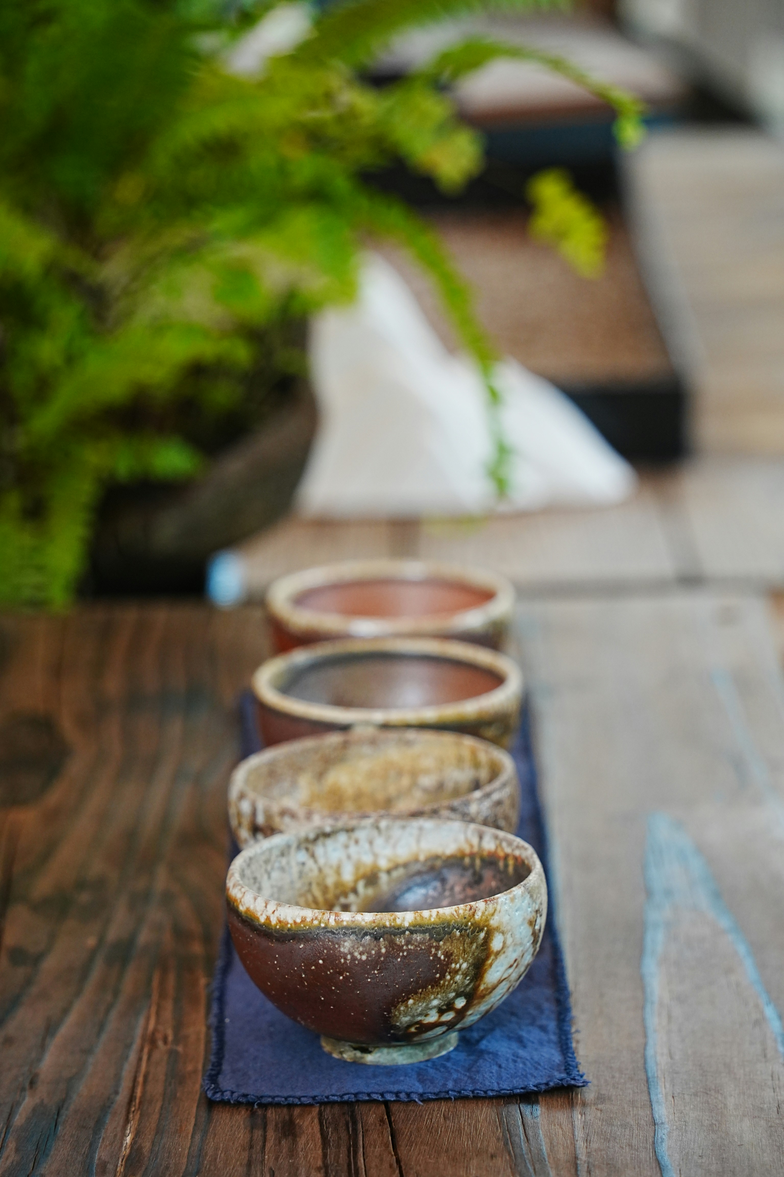 Line of Glaze: Five Bowls on a Weathered Wooden Table