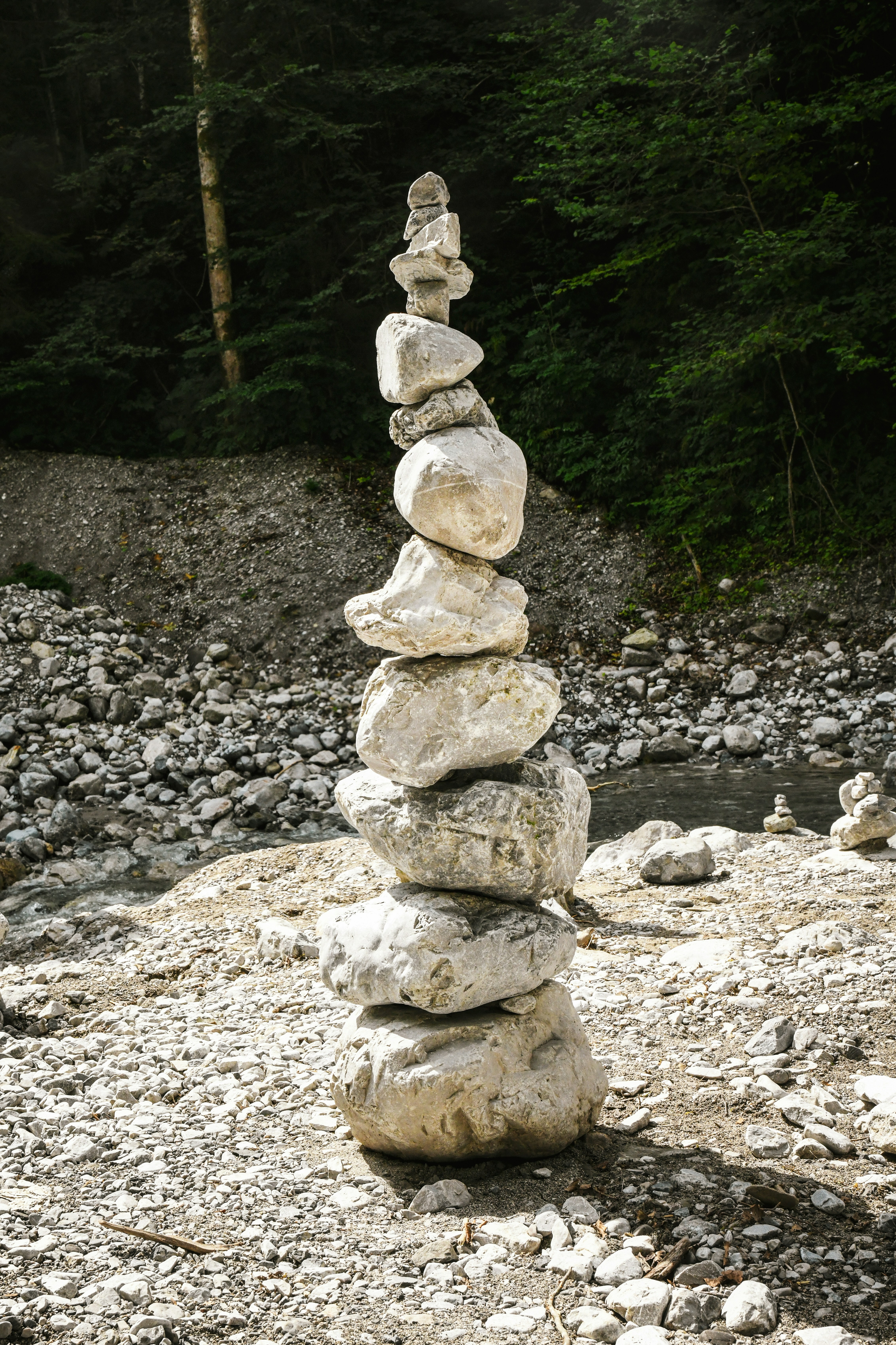 Cairn Crown on a Pebble Riverbank, Quiet in the Forest