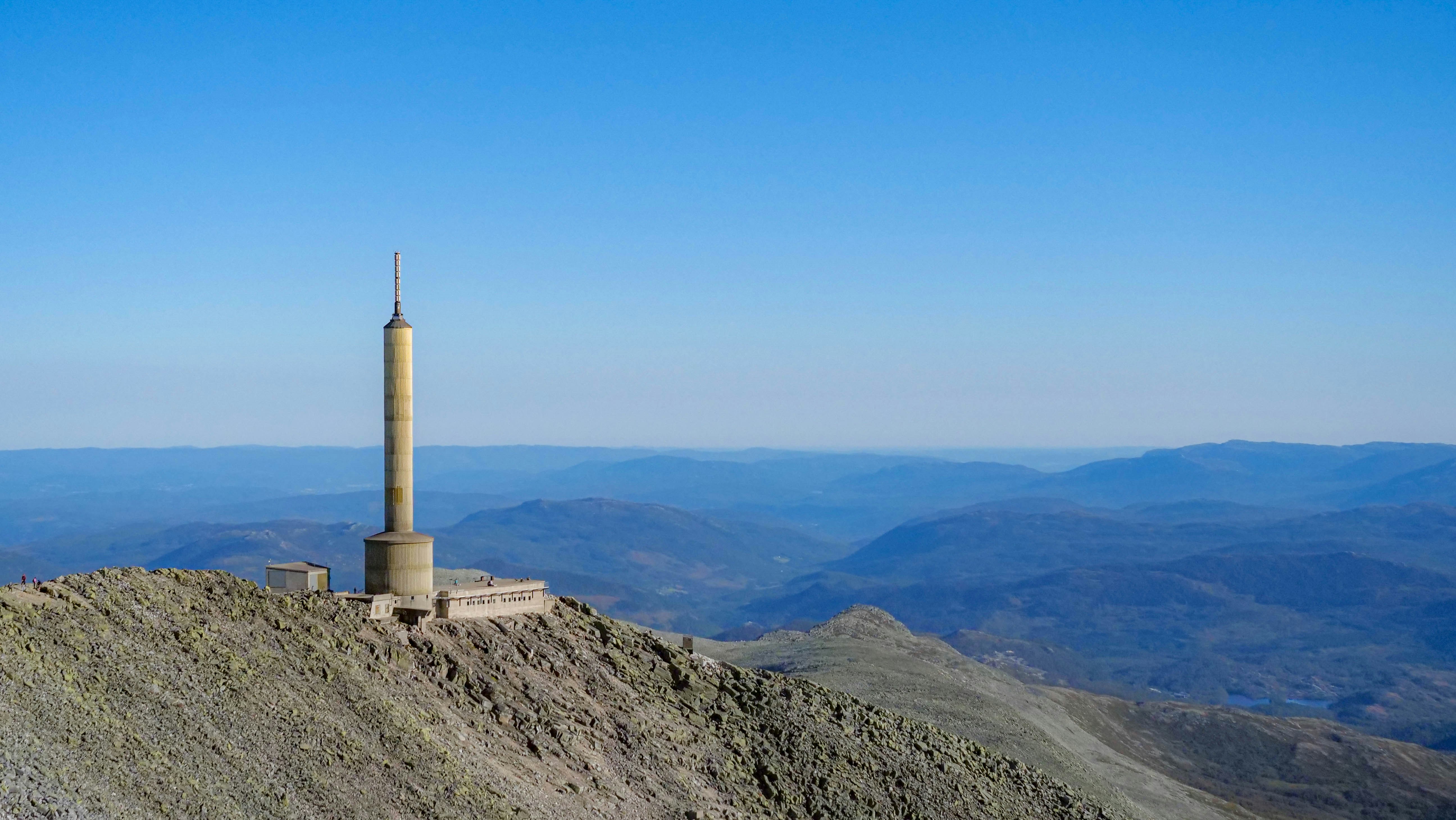 Beacon on the Ridge: A Lonely Tower Over Rolling Peaks