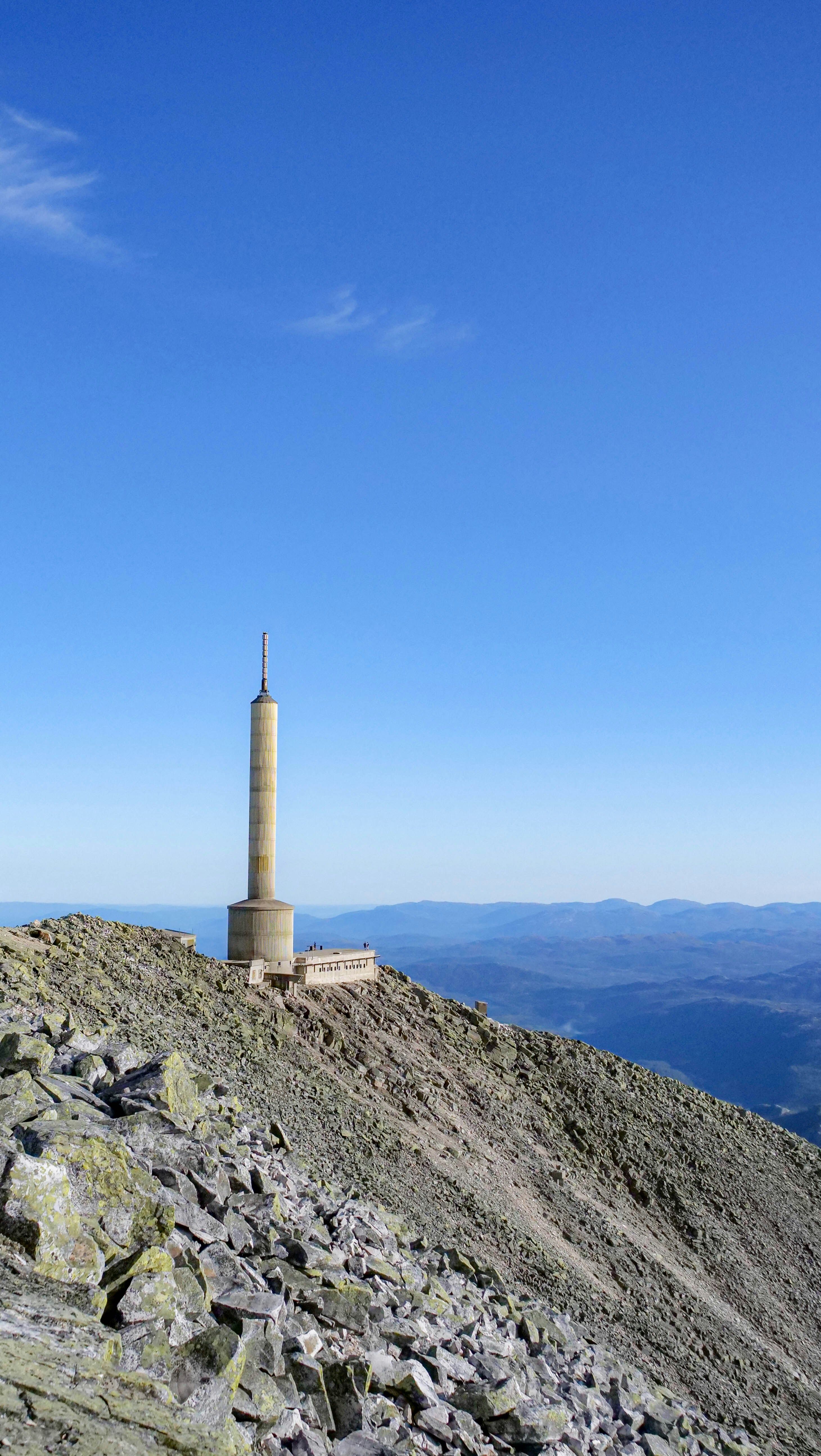 Stone Sentinel at the Crest: A Mountain Summit Tower