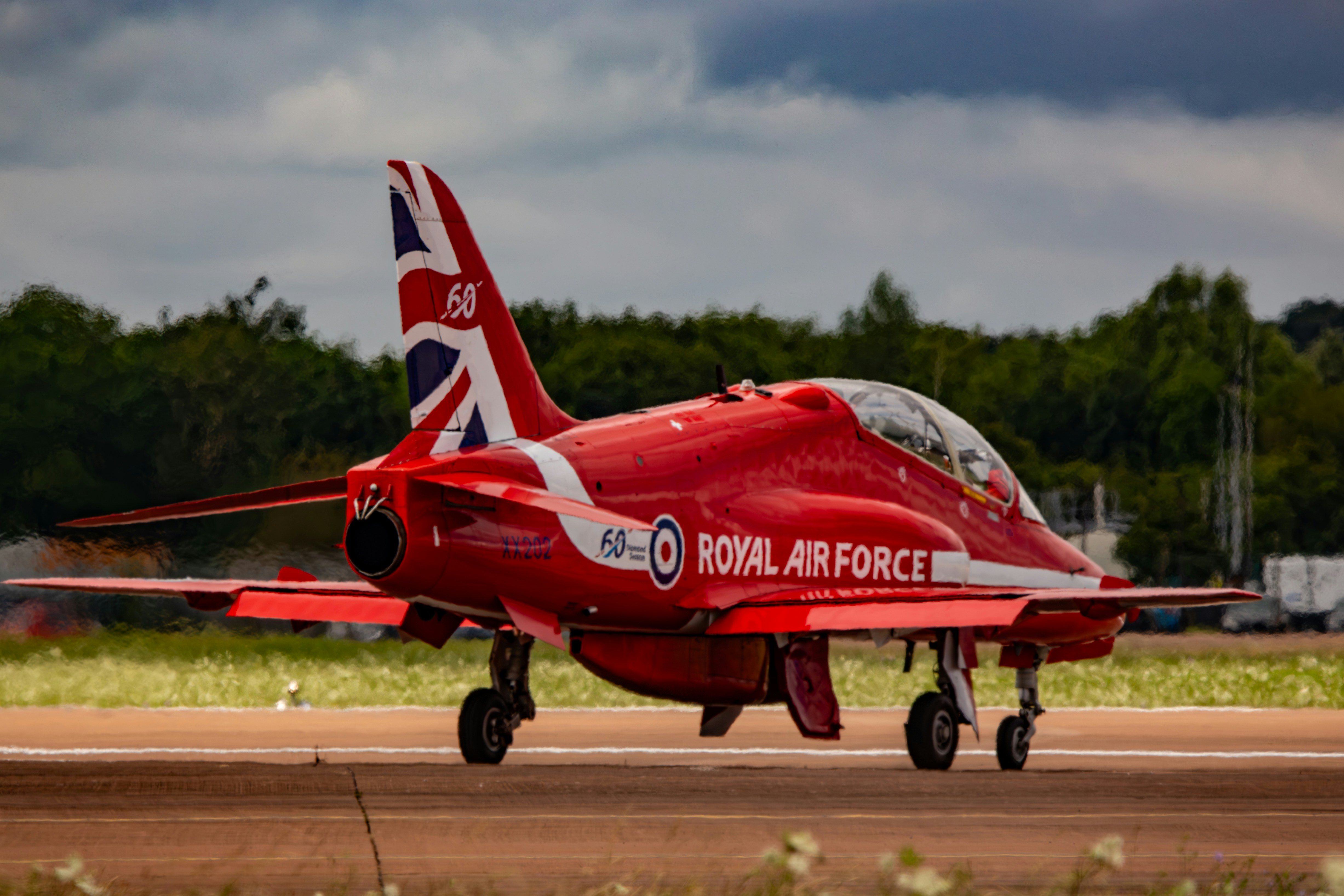 A red fighter jet sitting on top of an airport runway photo – Free ...