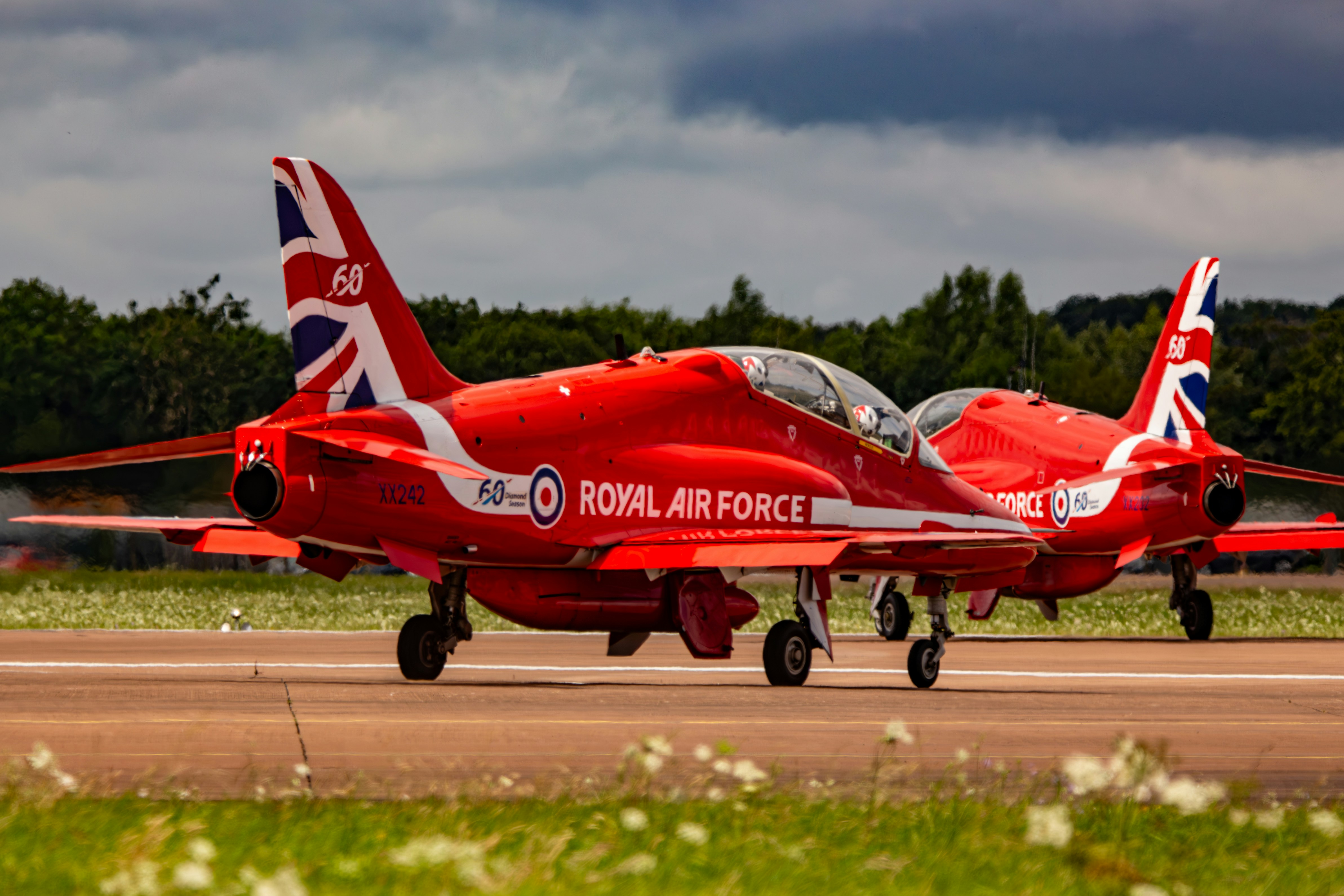 A red fighter jet sitting on top of an airport runway photo – Free ...