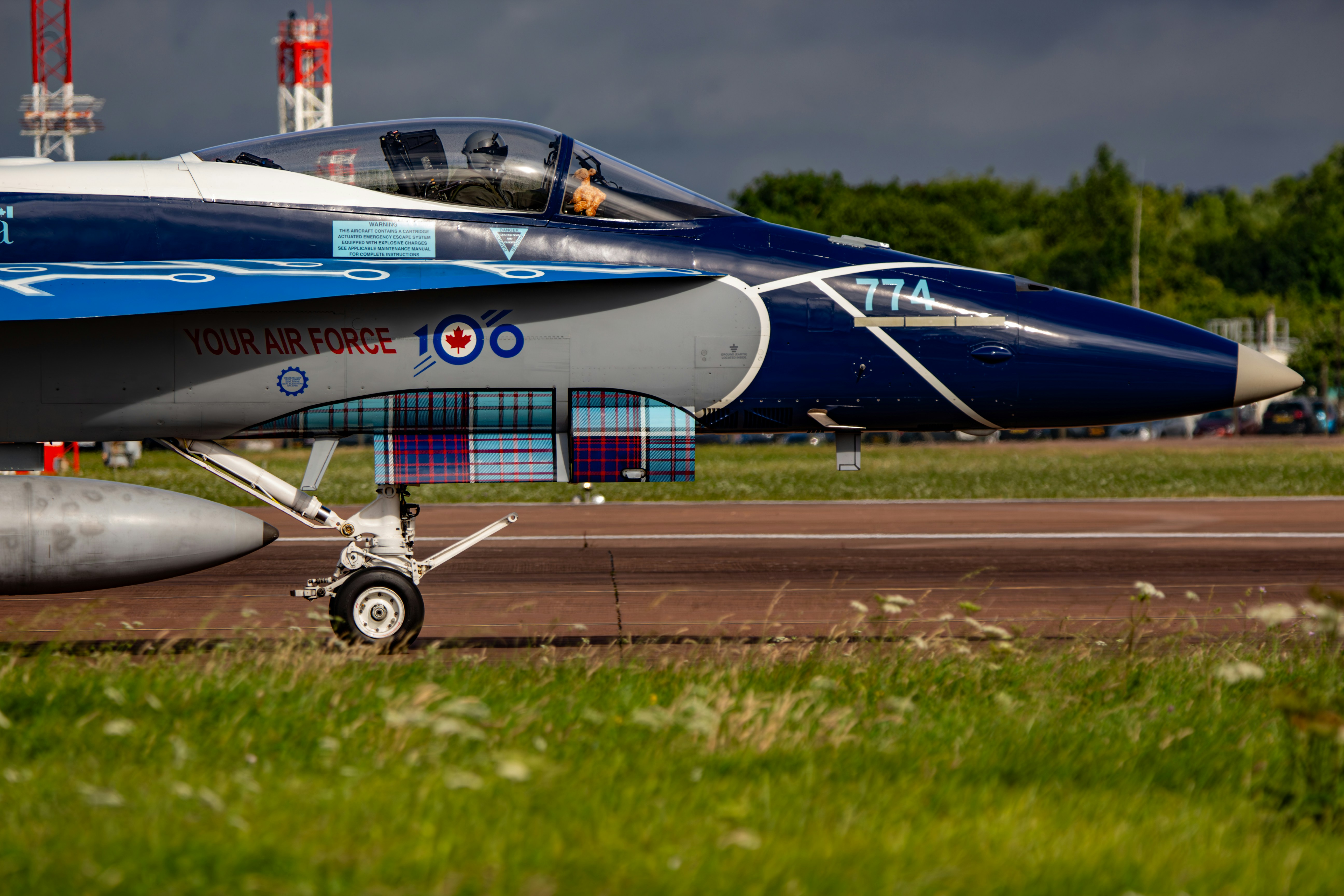 A blue and white jet sitting on top of a runway photo – Free Airfield ...
