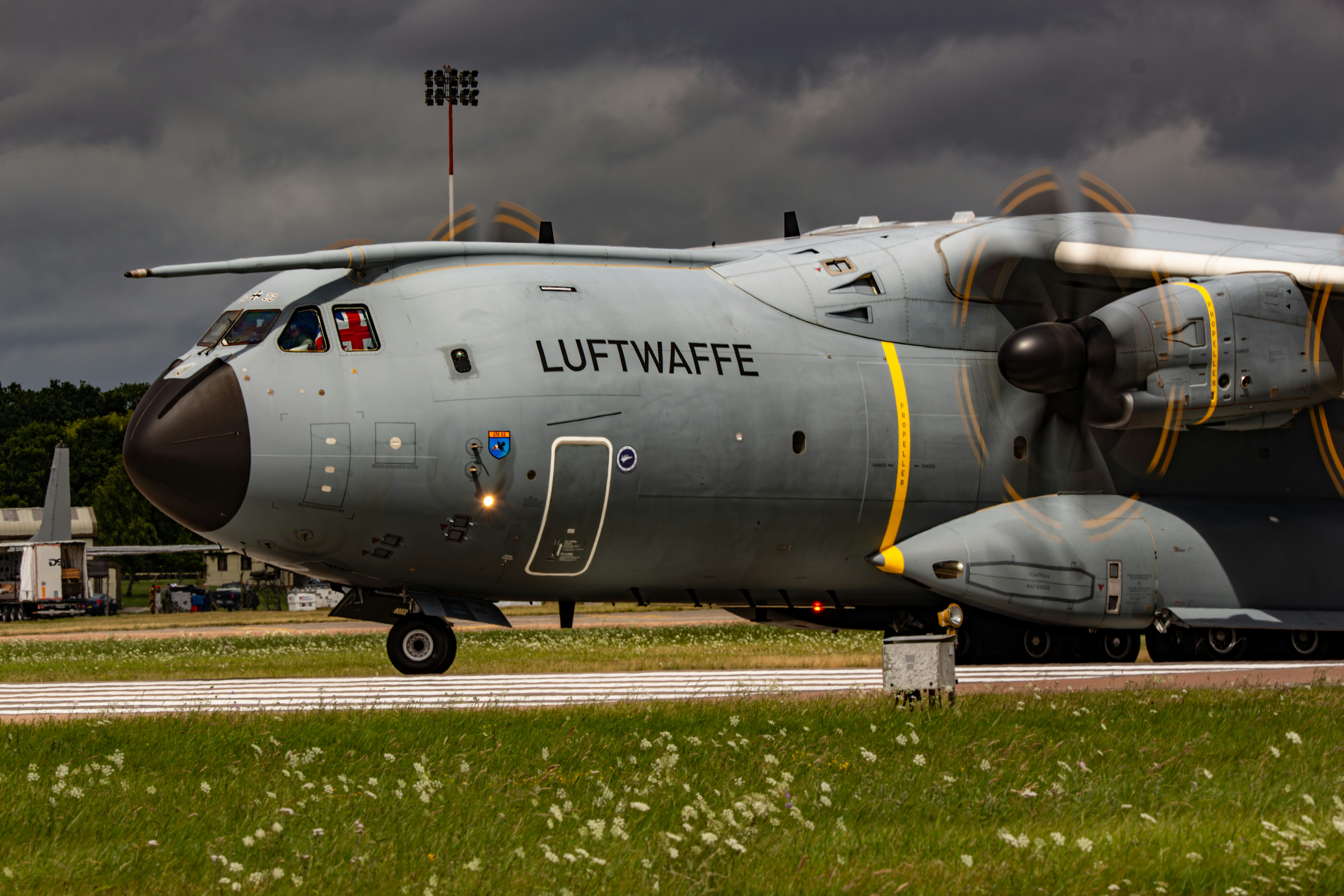 A large military plane sitting on top of a runway photo – Free Airfield ...