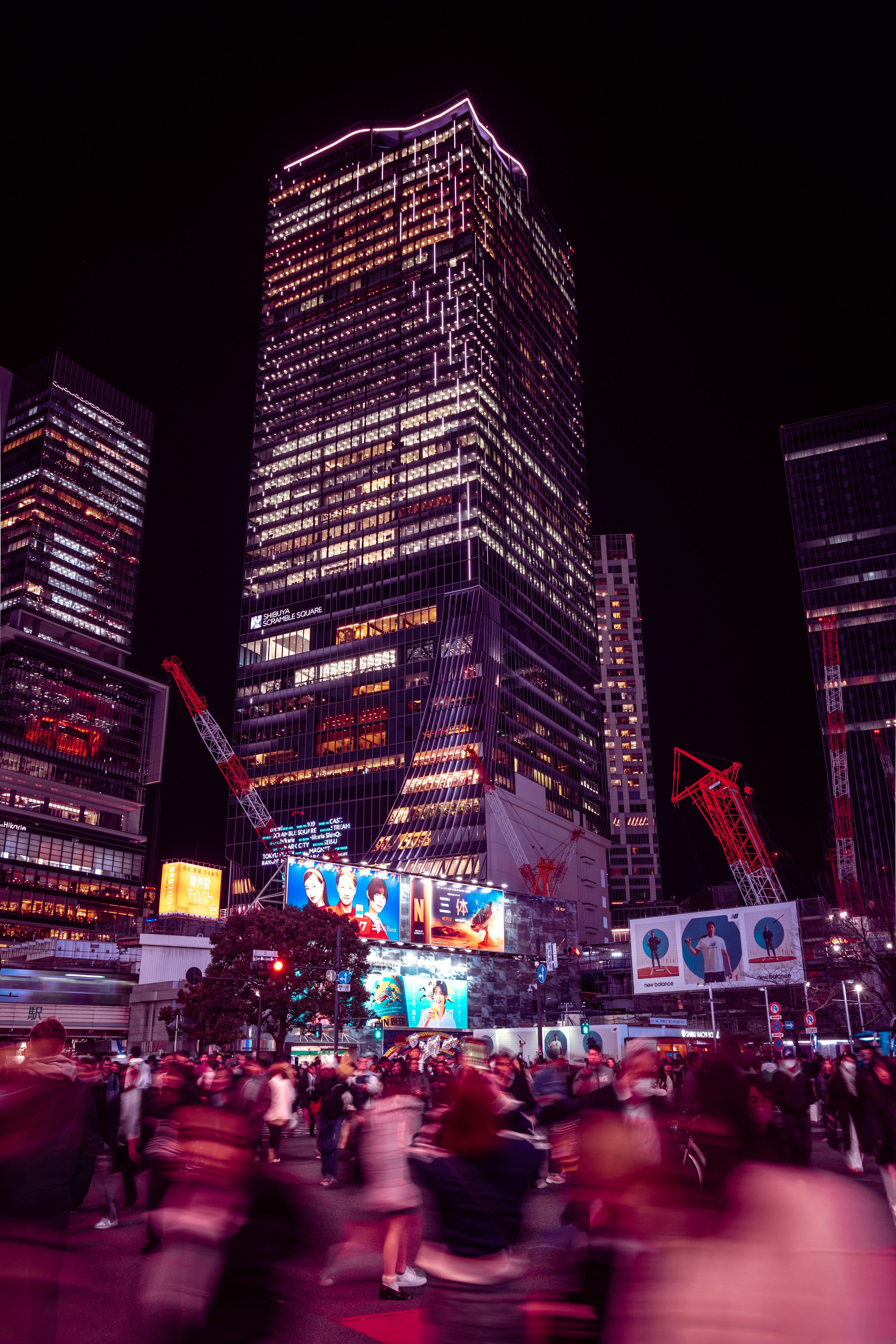 A crowd of people walking around a city at night photo – Free Tokyo ...