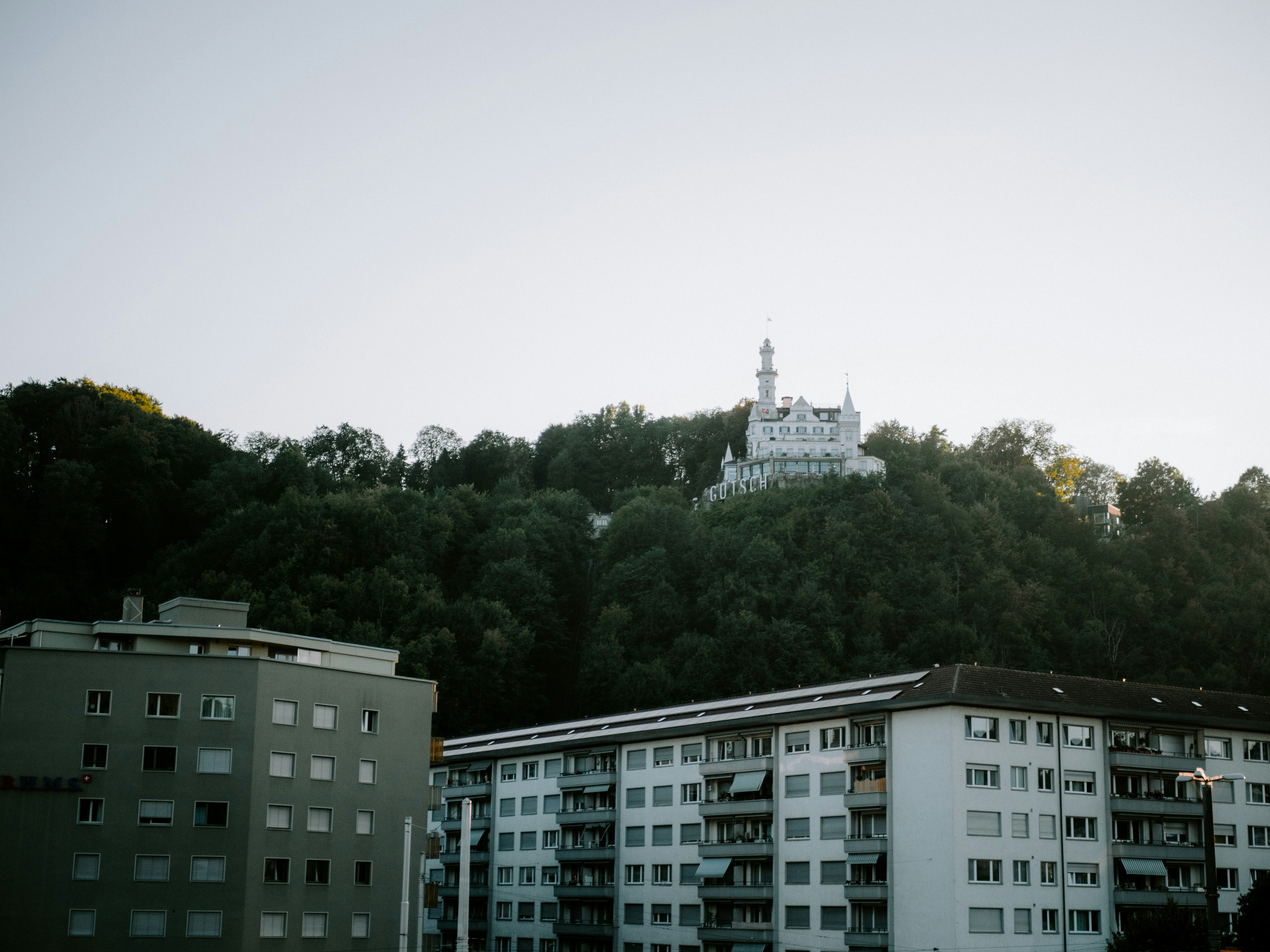 White Hilltop Castle Overlooking a Quiet Suburban Horizon