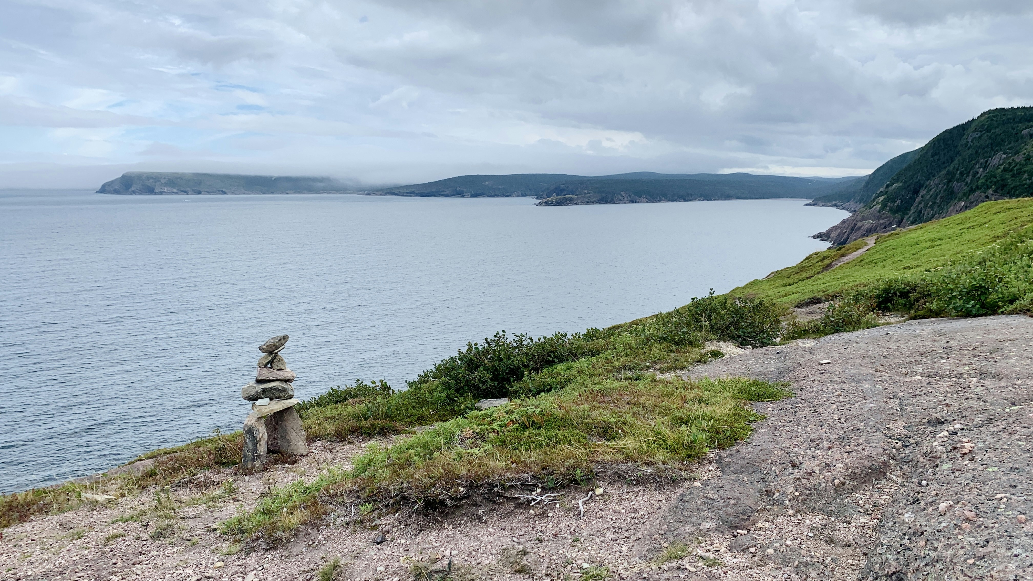 Stone Stack by the Sea: Quiet Cliffs and Green Slopes