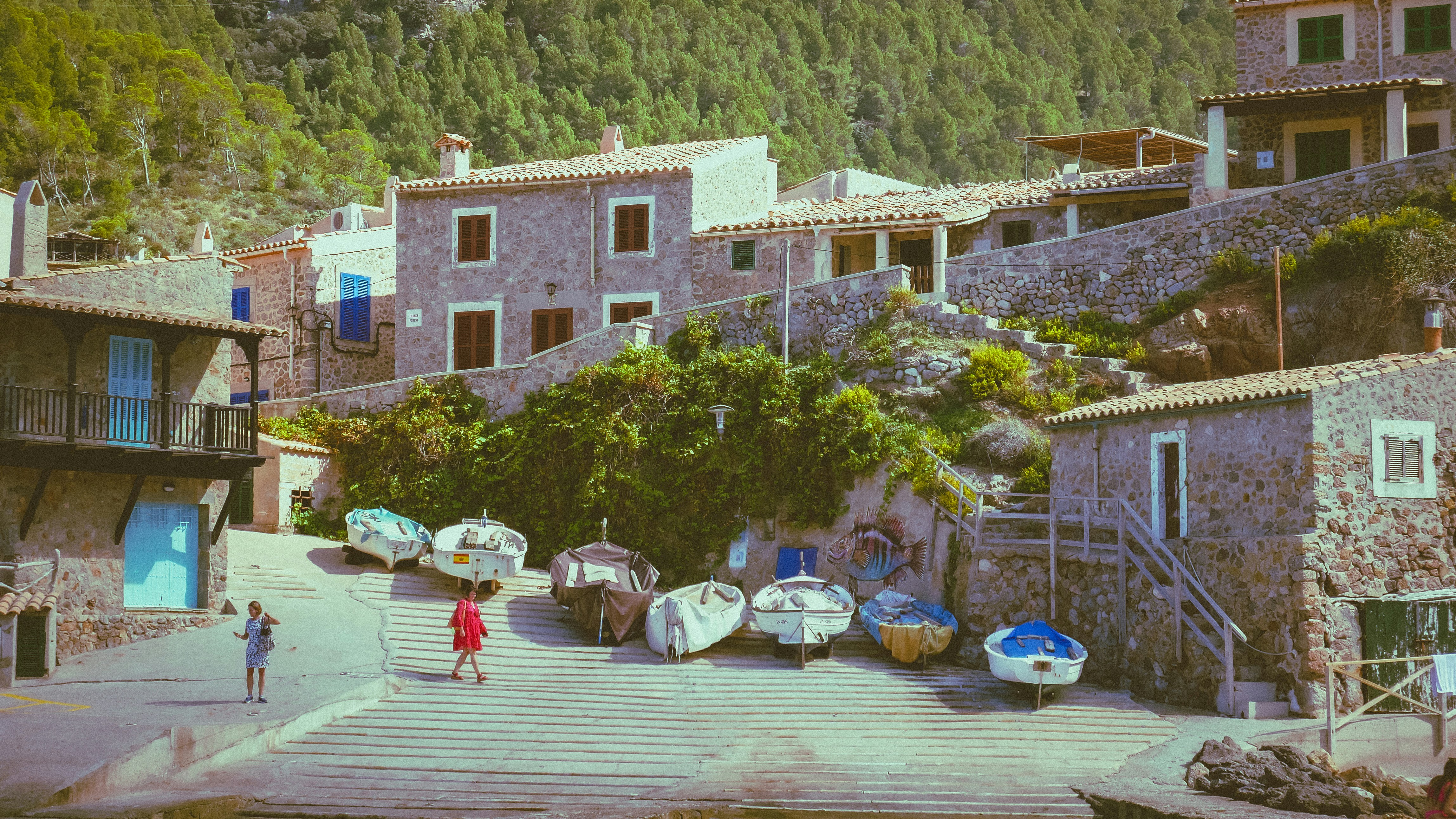 Harbor Steps: Boats Rest Along a Sunlit Stone Village