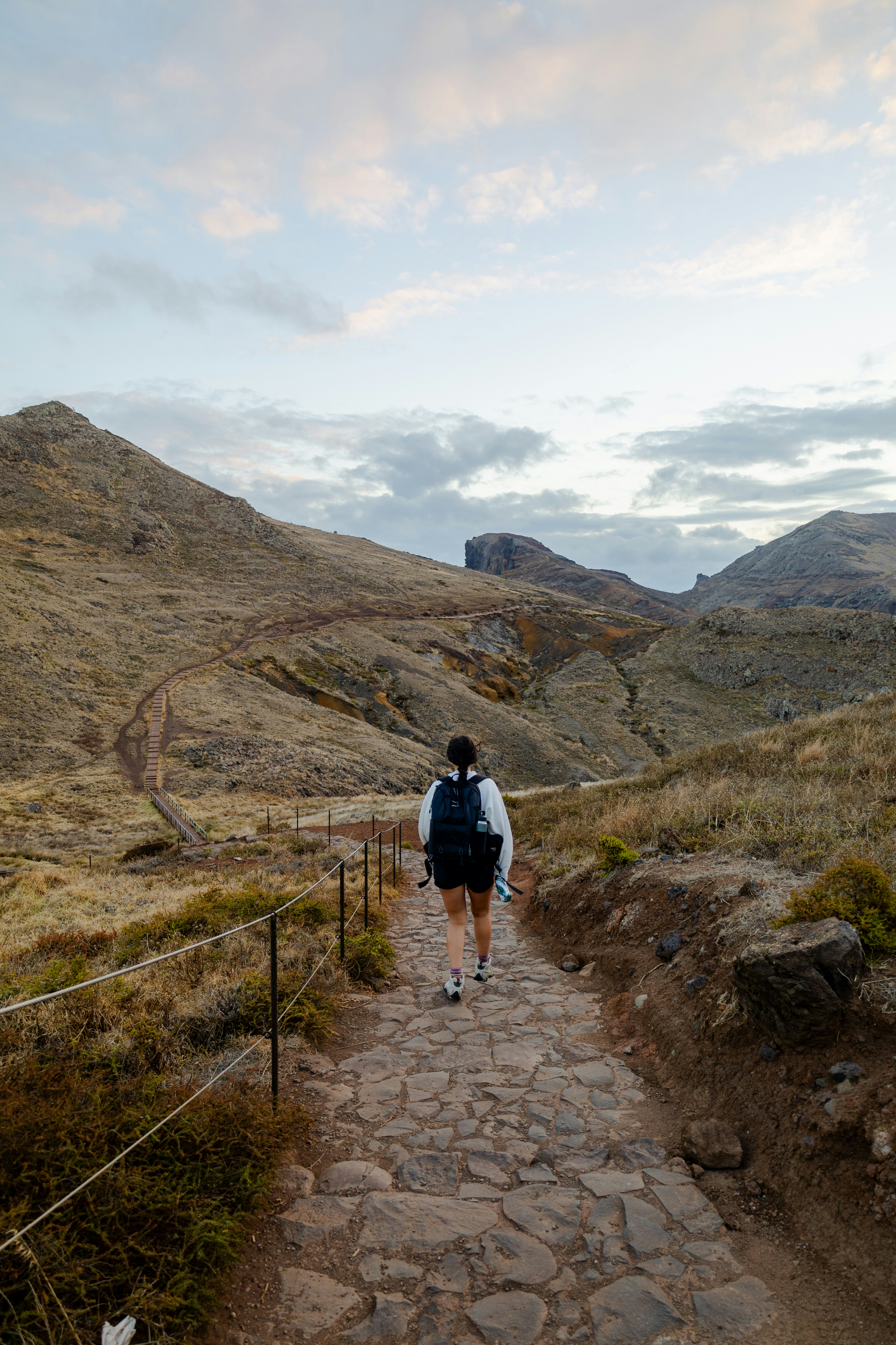 A person walking up a path in the mountains photo – Free Sunrise Image ...