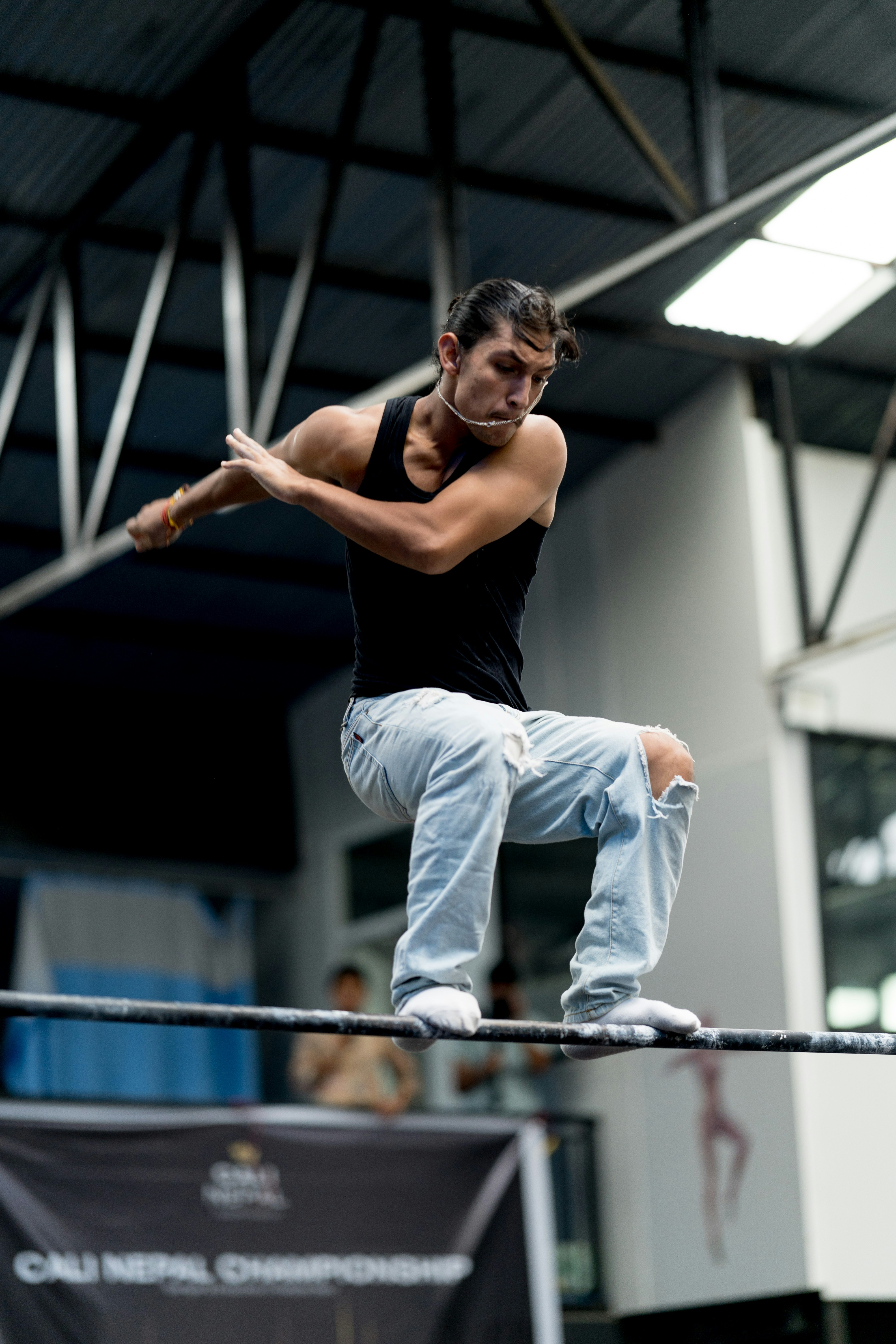 A man balances on a rope in a gym photo – Free Image on Unsplash