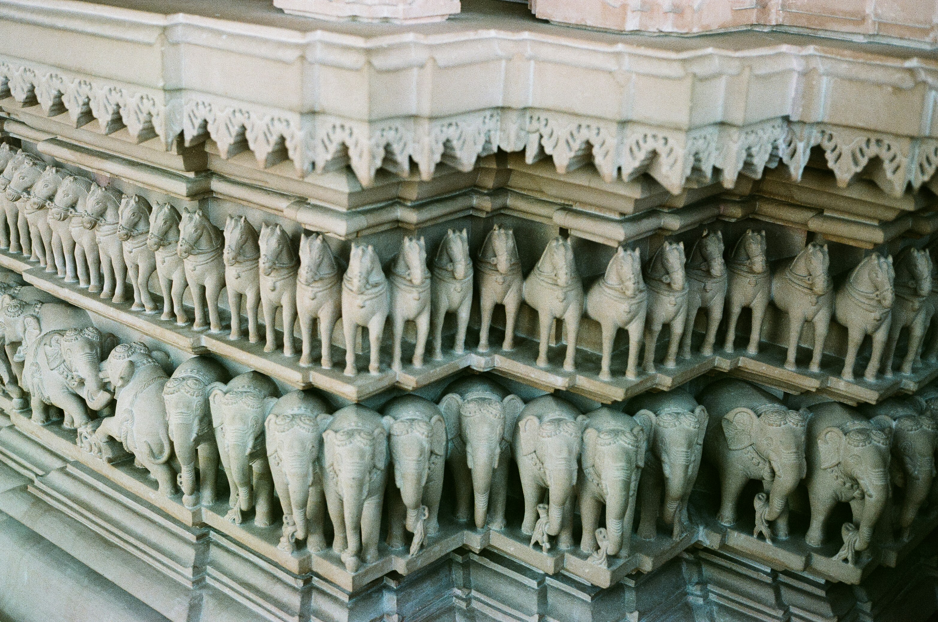 A group of elephants carved into the side of a building photo – Free ...