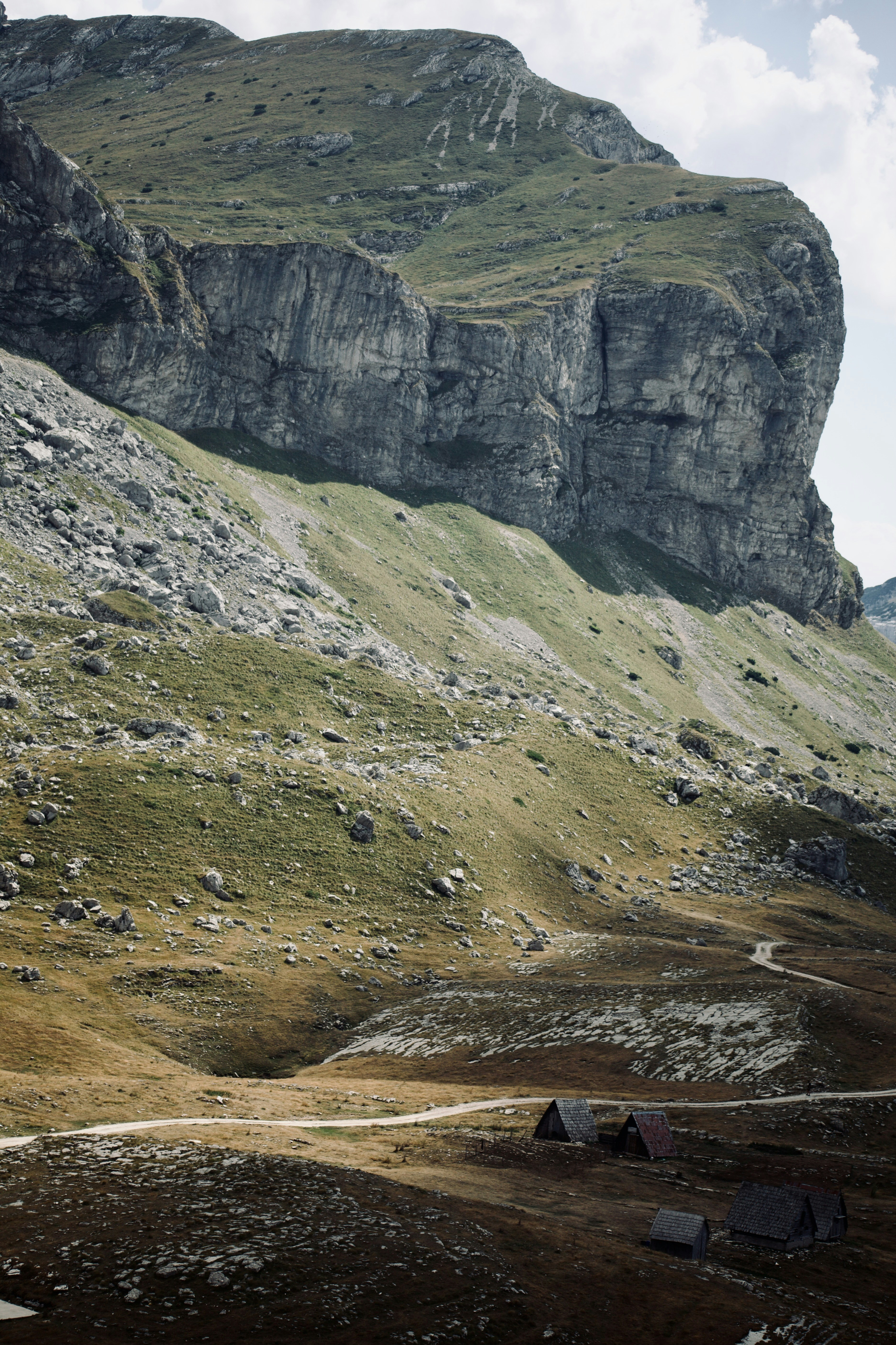 Stone Crown Over the Valley: A Mountain Cliff Watches Over a Humble Camp