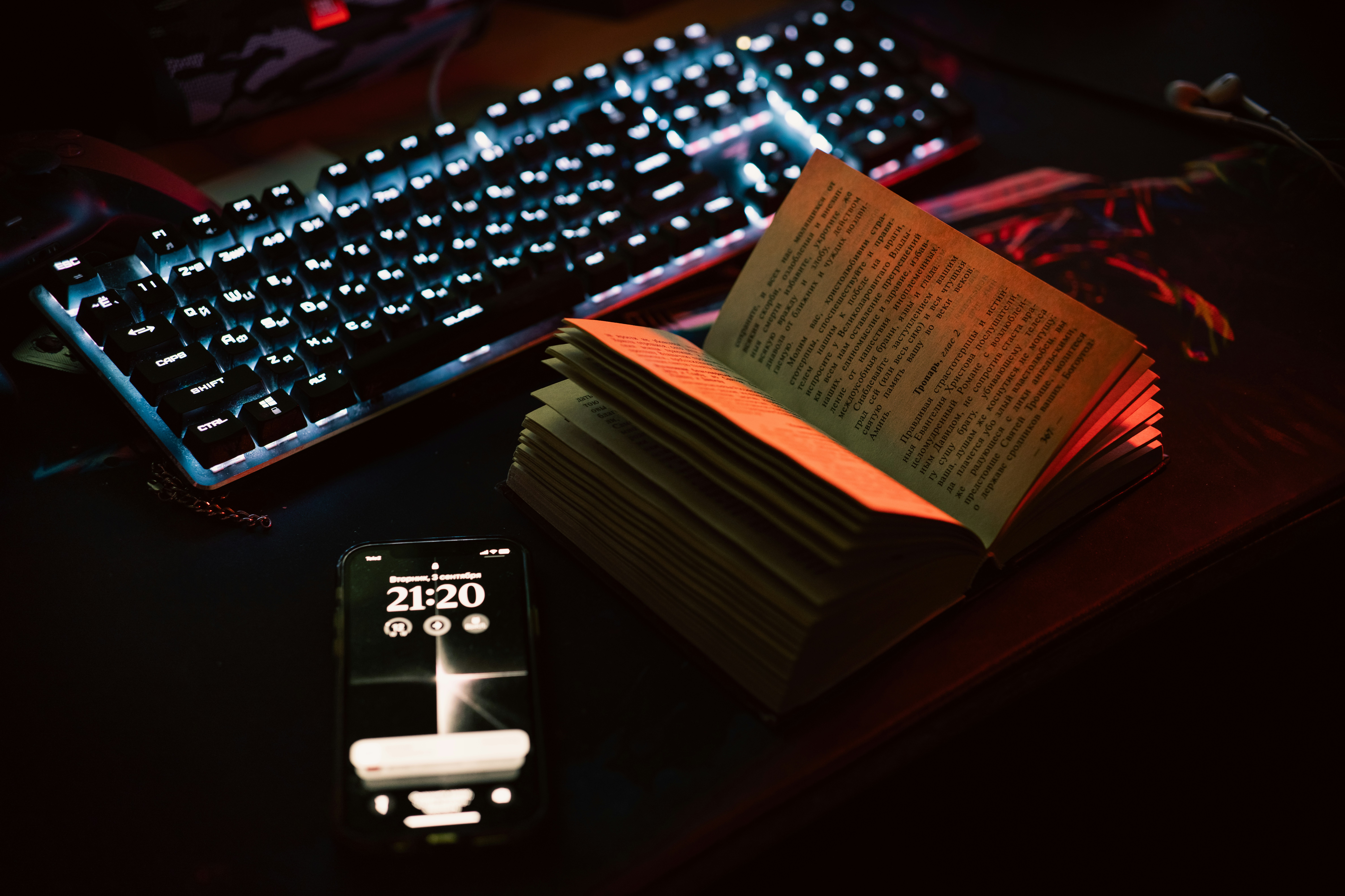 Night Desk Ritual: Neon Keyboard, Open Pages, and a Glowing Phone