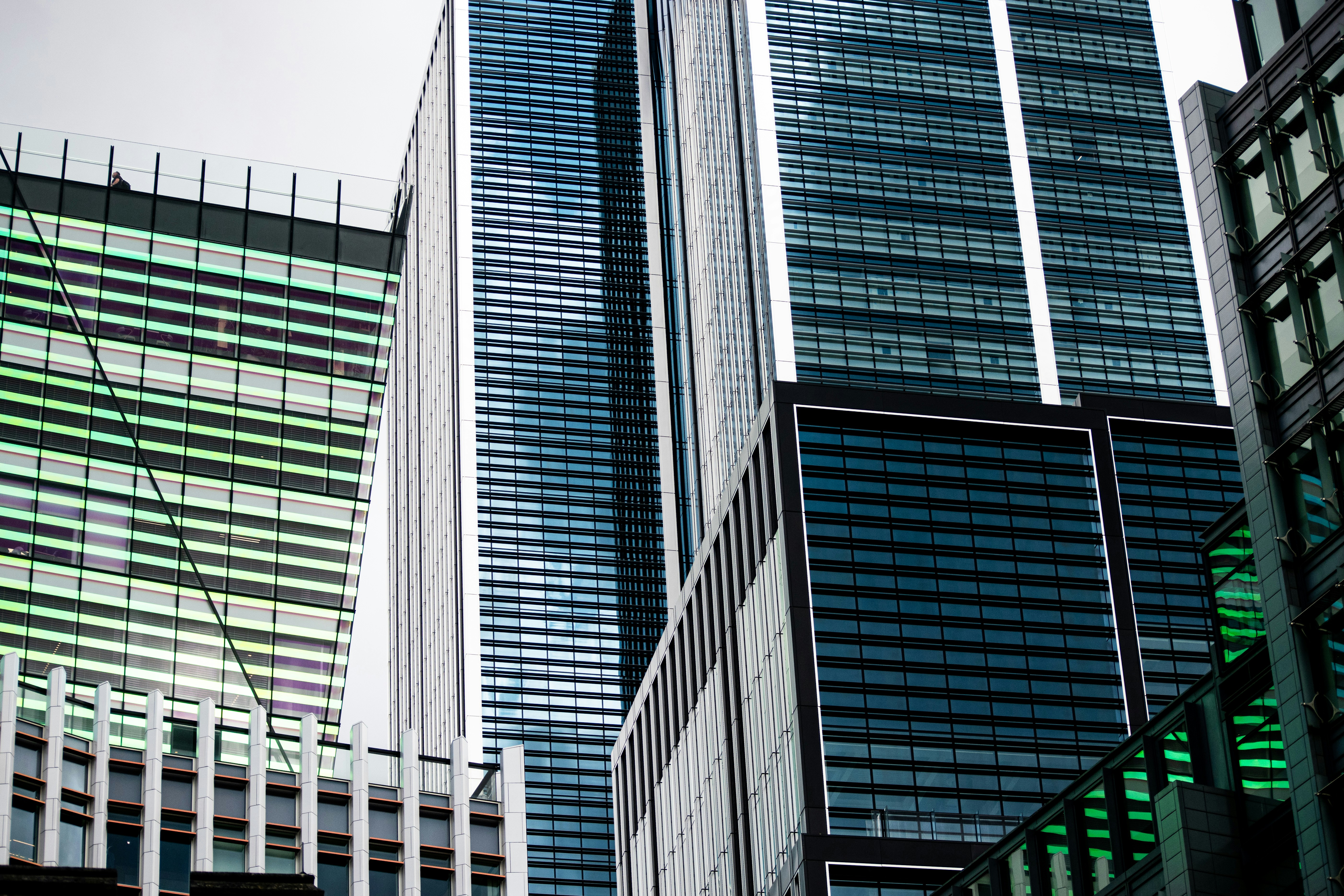 Modern skyscrapers with reflective glass façades and geometric lines, showcasing a blend of architecture and urban design.