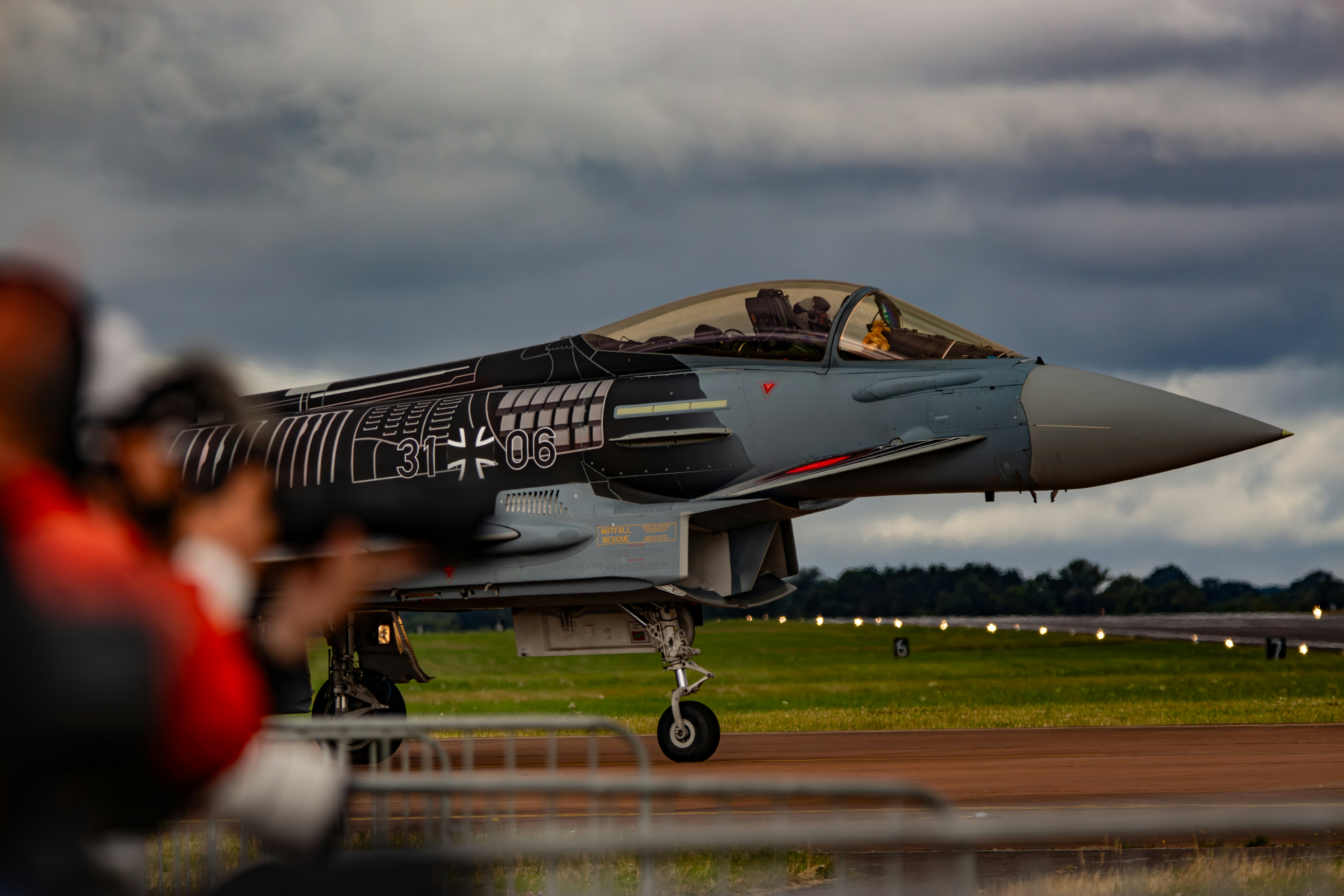 A fighter jet sitting on top of an airport tarmac photo – Free Airport ...