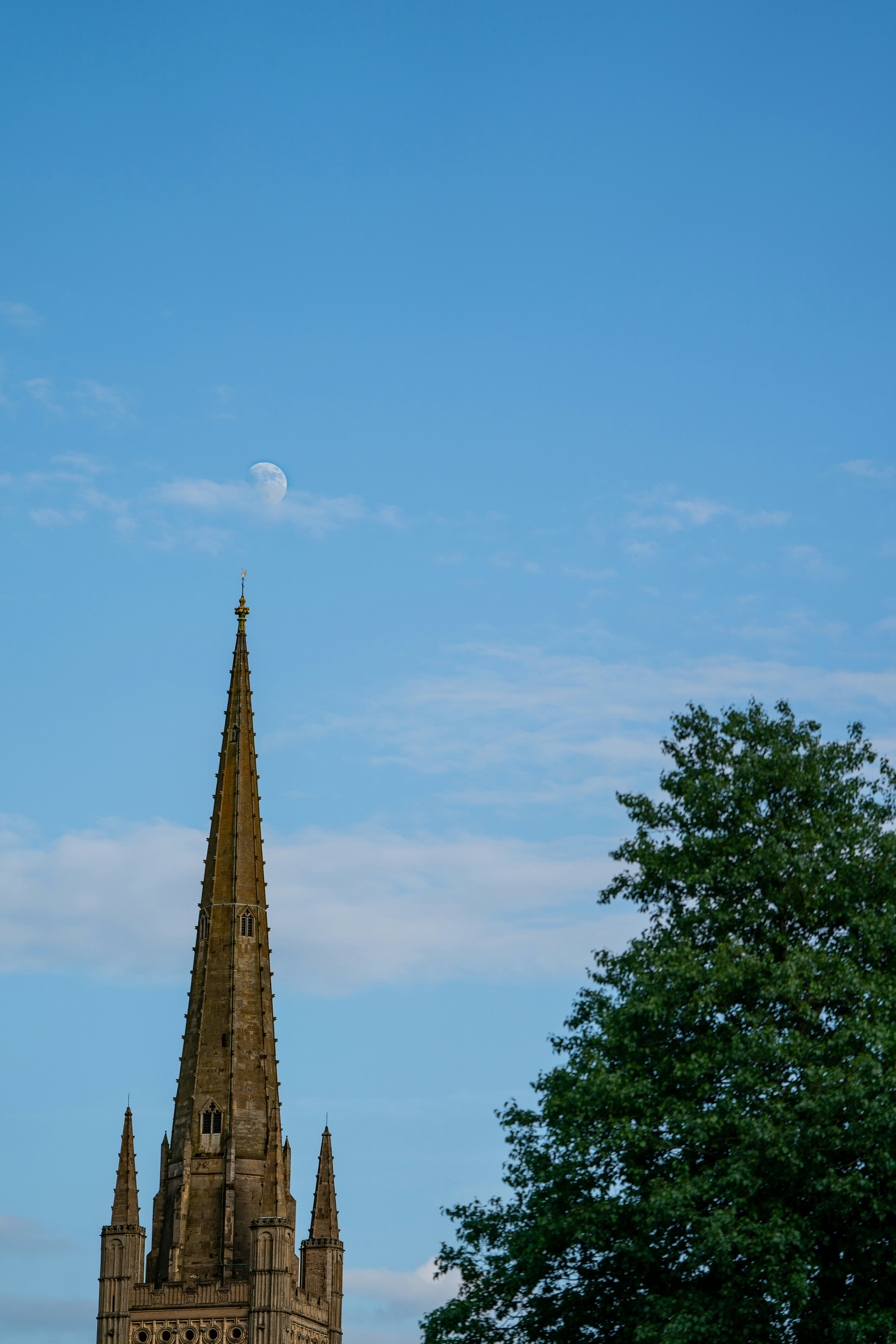 A church steeple with a half moon in the background photo – Free Spire ...