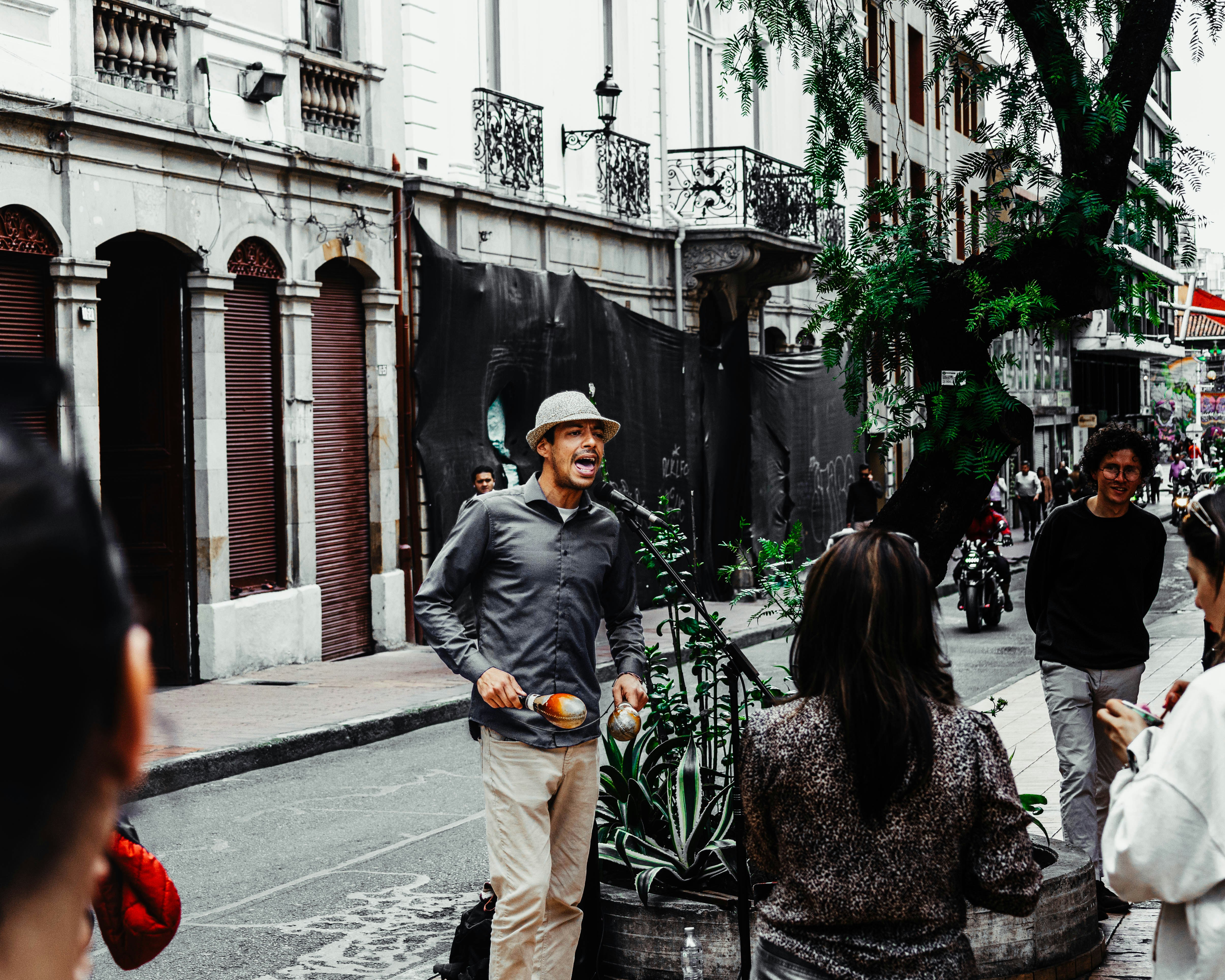 Urban Serenade: Street Performer Engages Passersby