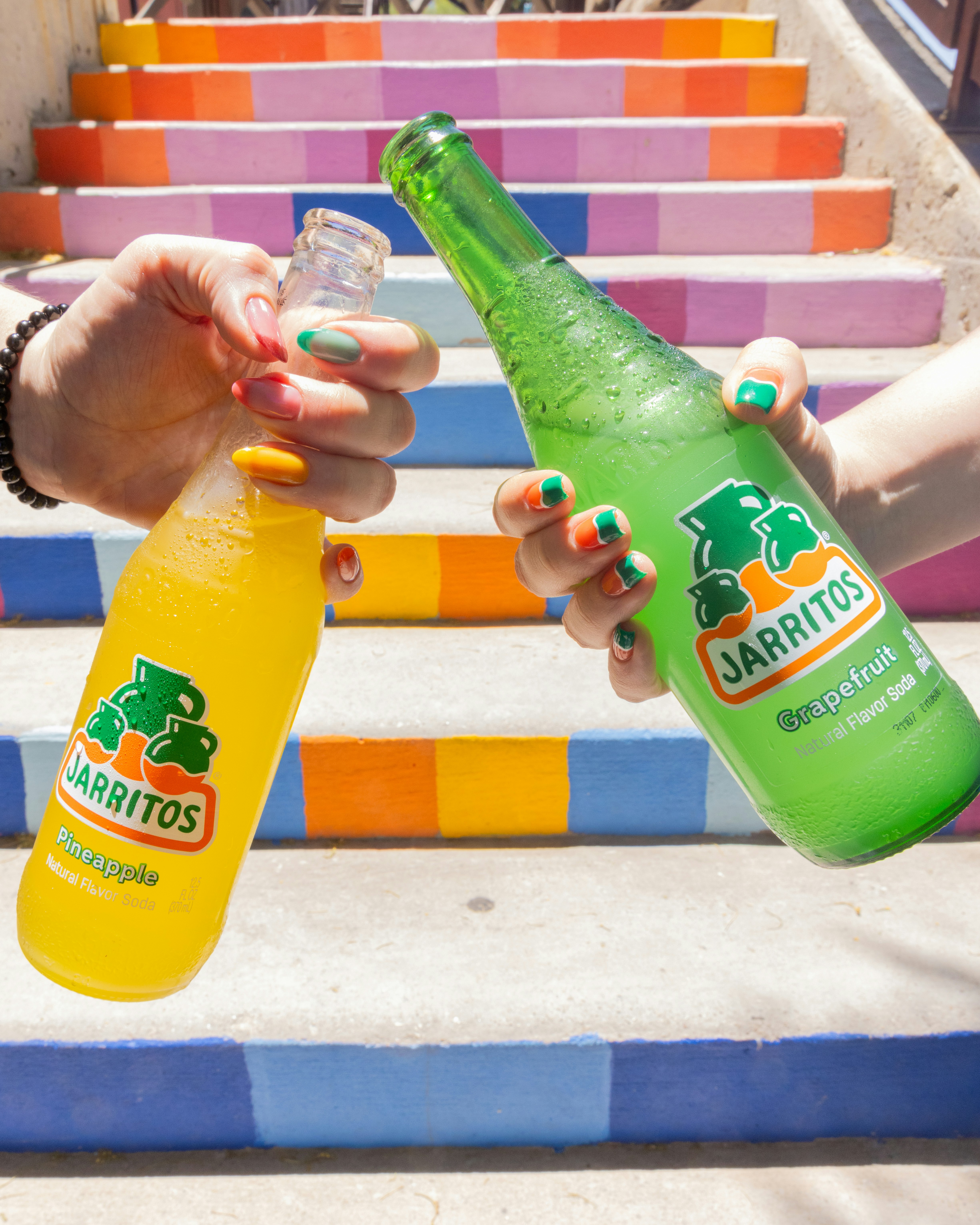 Color-Charged Toast on Rainbow Steps: Jarritos Bottles in a Sunlit Moment