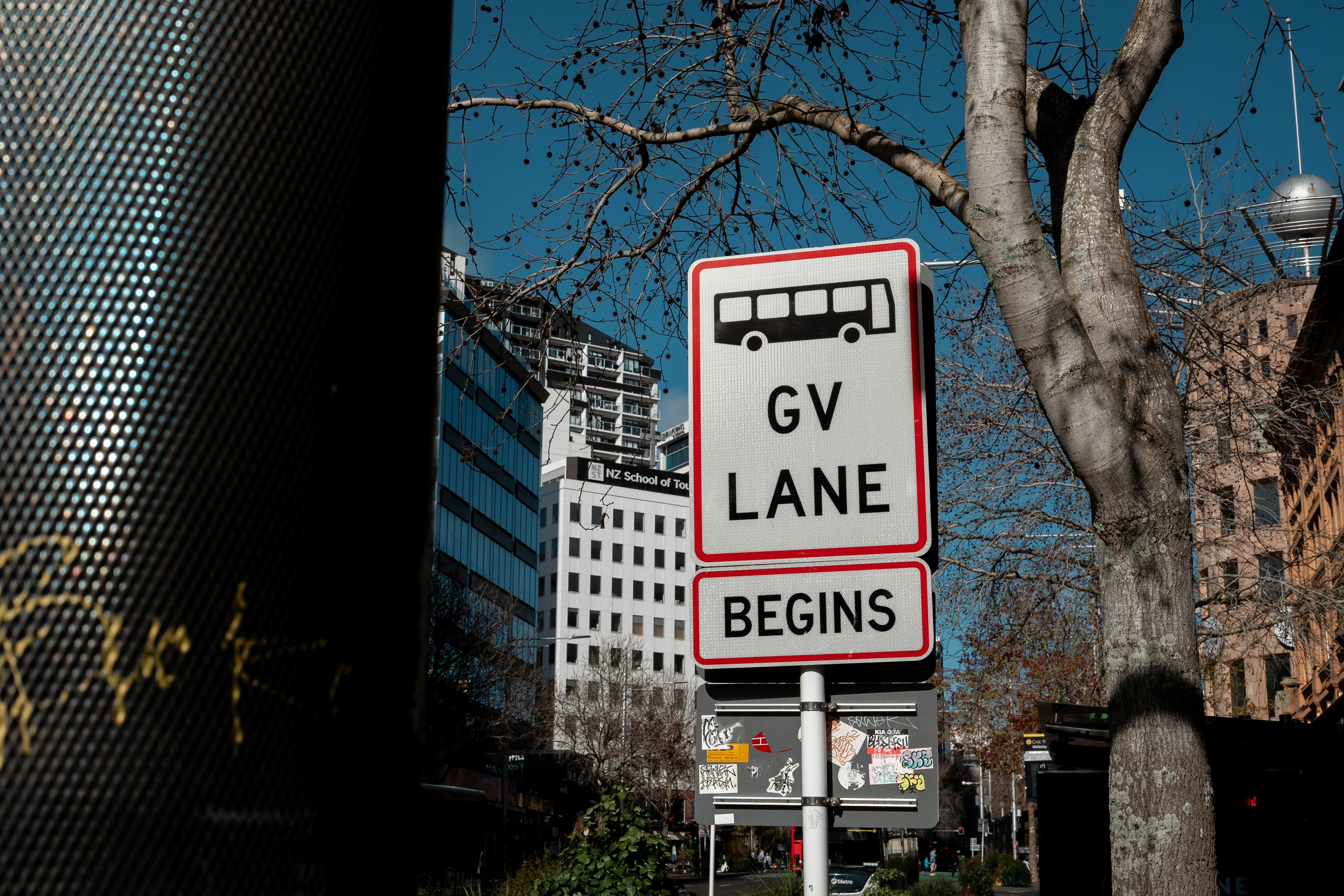A street sign on a city street with buildings in the background photo ...