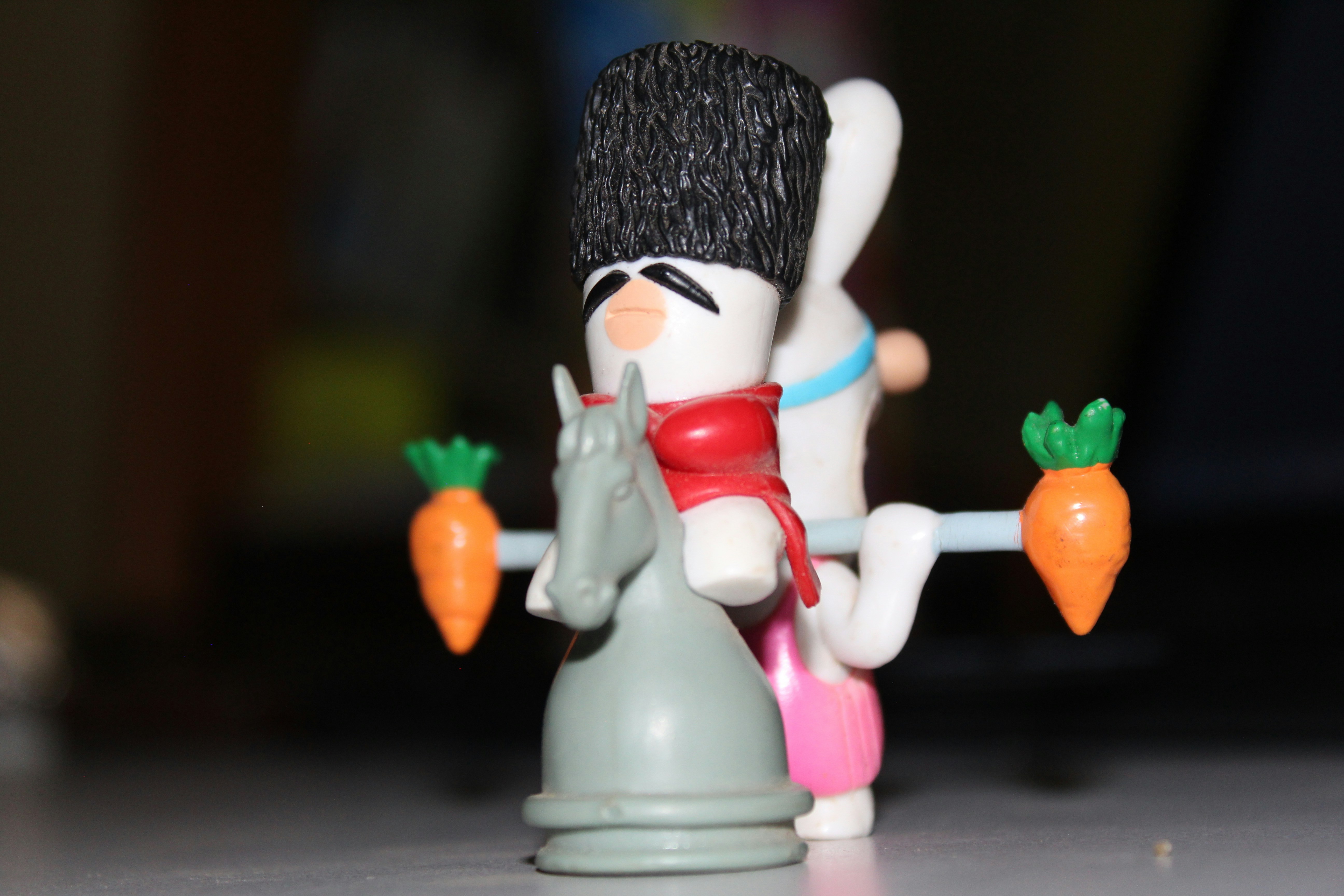 A vibrant toy soldier riding a gray horse, holding carrots. The playful expression and colorful details make this figurine an excellent choice for collectors and toy enthusiasts alike.