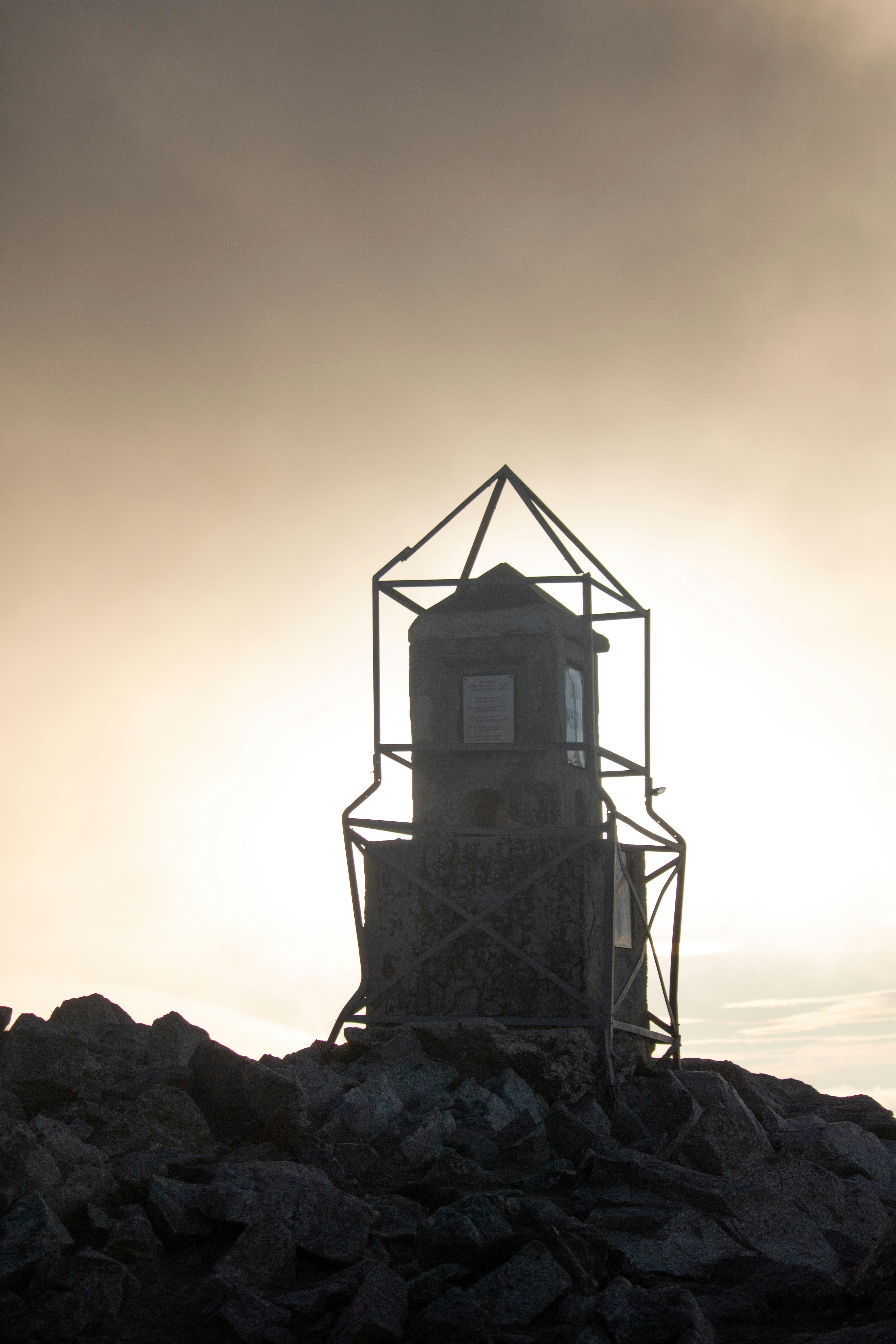 Backlit Sentinel: Lighthouse Enclosed in a Geometric Cage