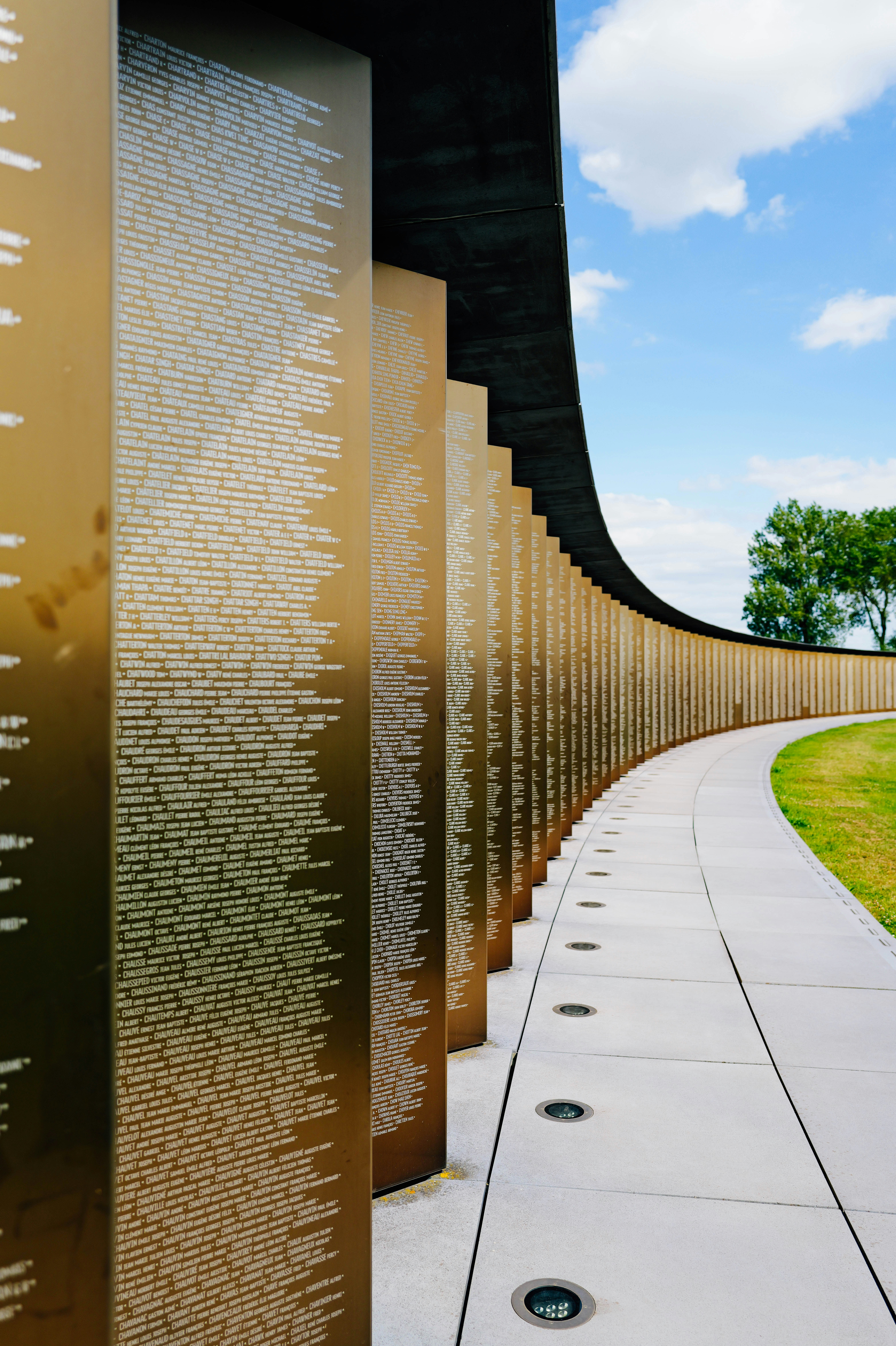 A wall of names on the side of a building photo – Free City Image on ...