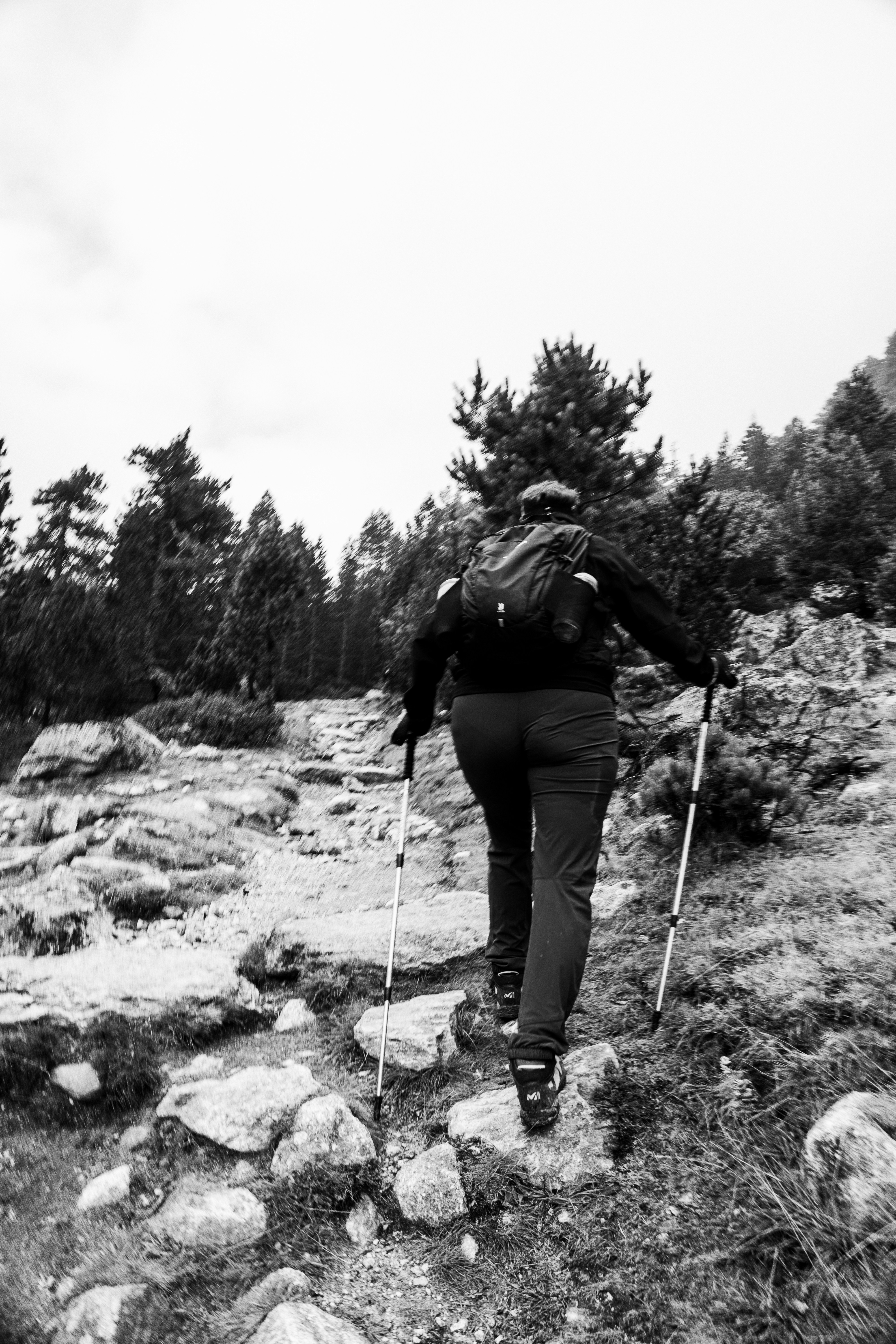 Climber's Ascent: Trekker Navigates a Rocky Trail