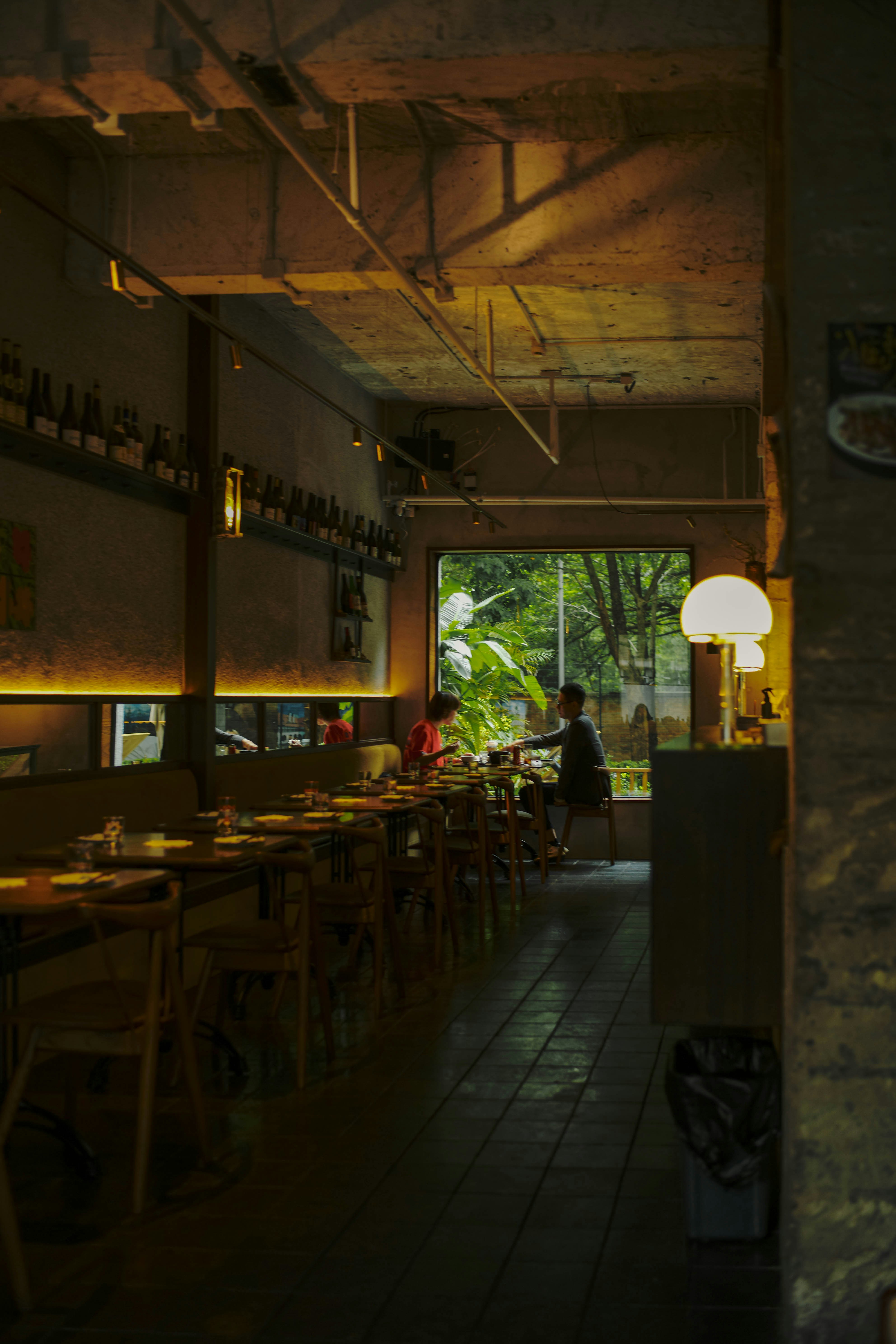 A dimly lit restaurant with a long table photo – Free Indoors Image on ...