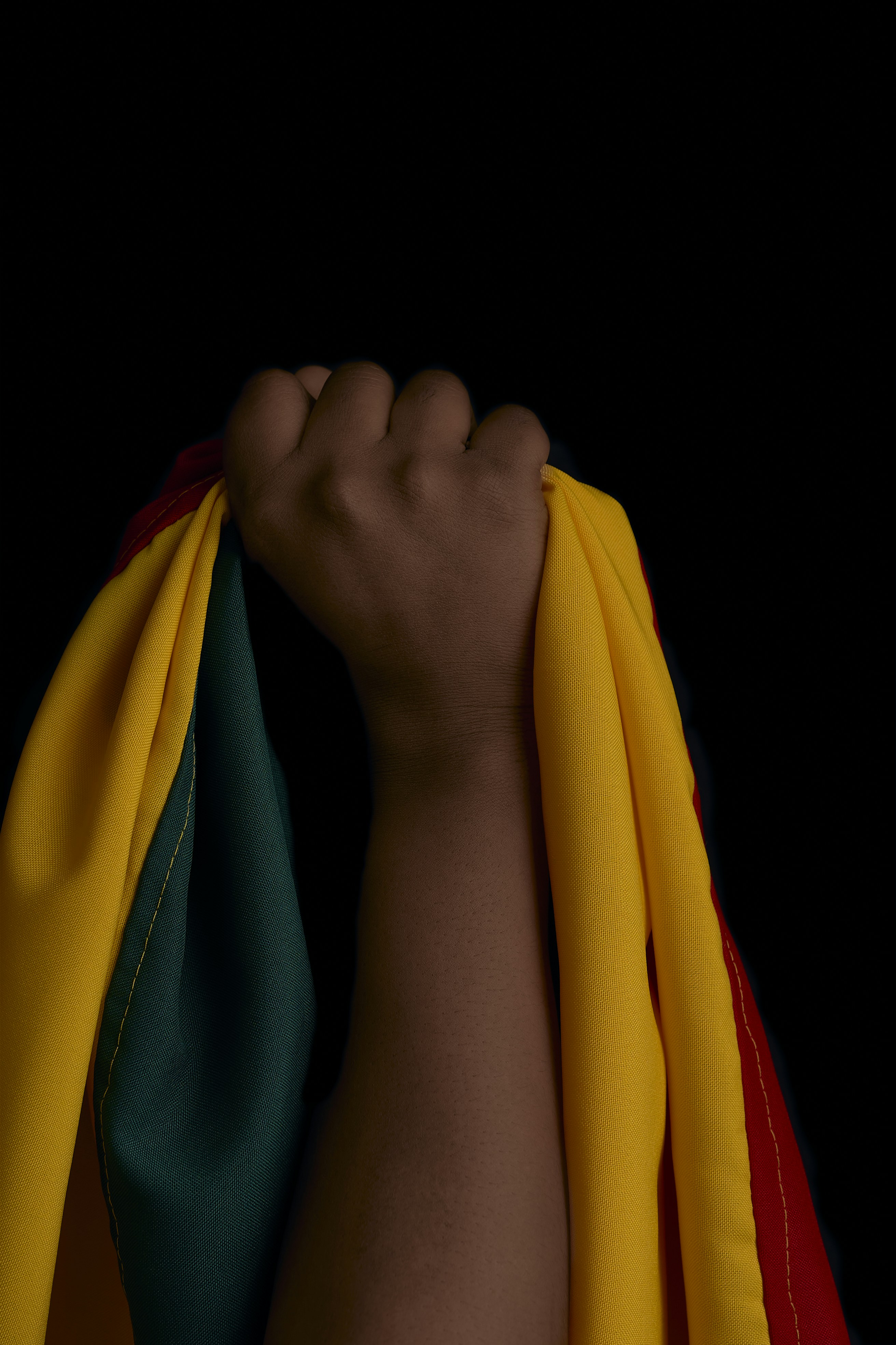Fist of Color: A Bold Gesture with a Rainbow Draped in Darkness