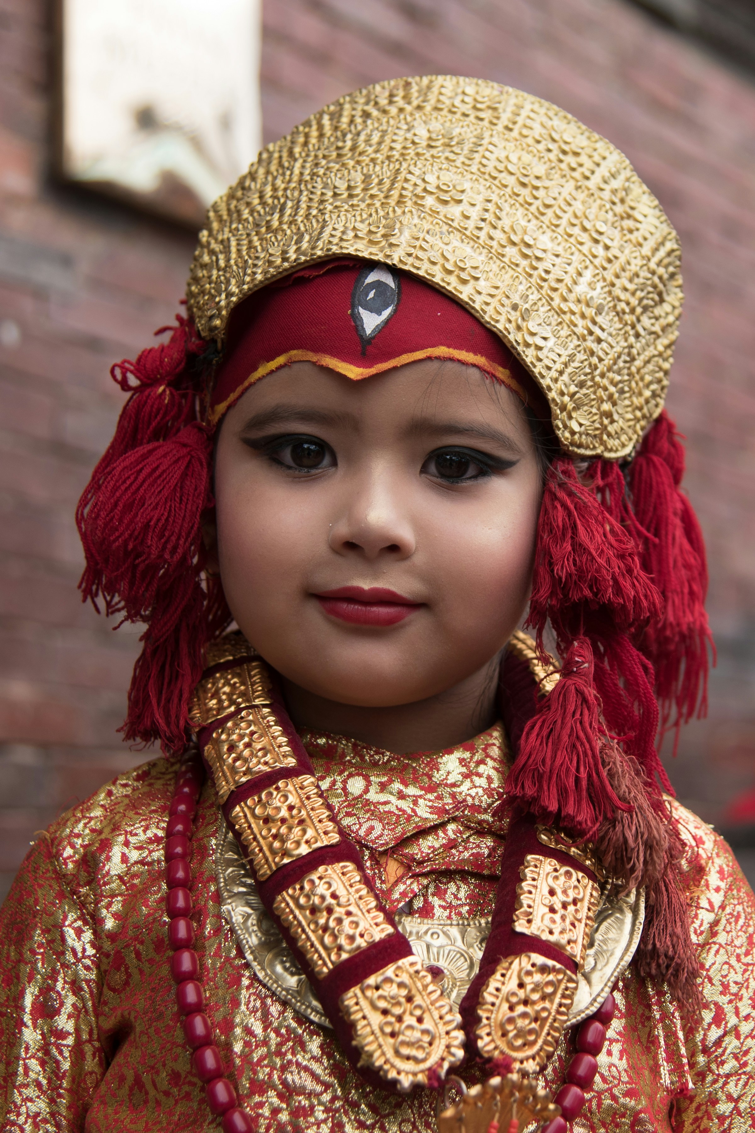 A young girl wearing a red and gold costume photo – Free Lalitpur Image ...