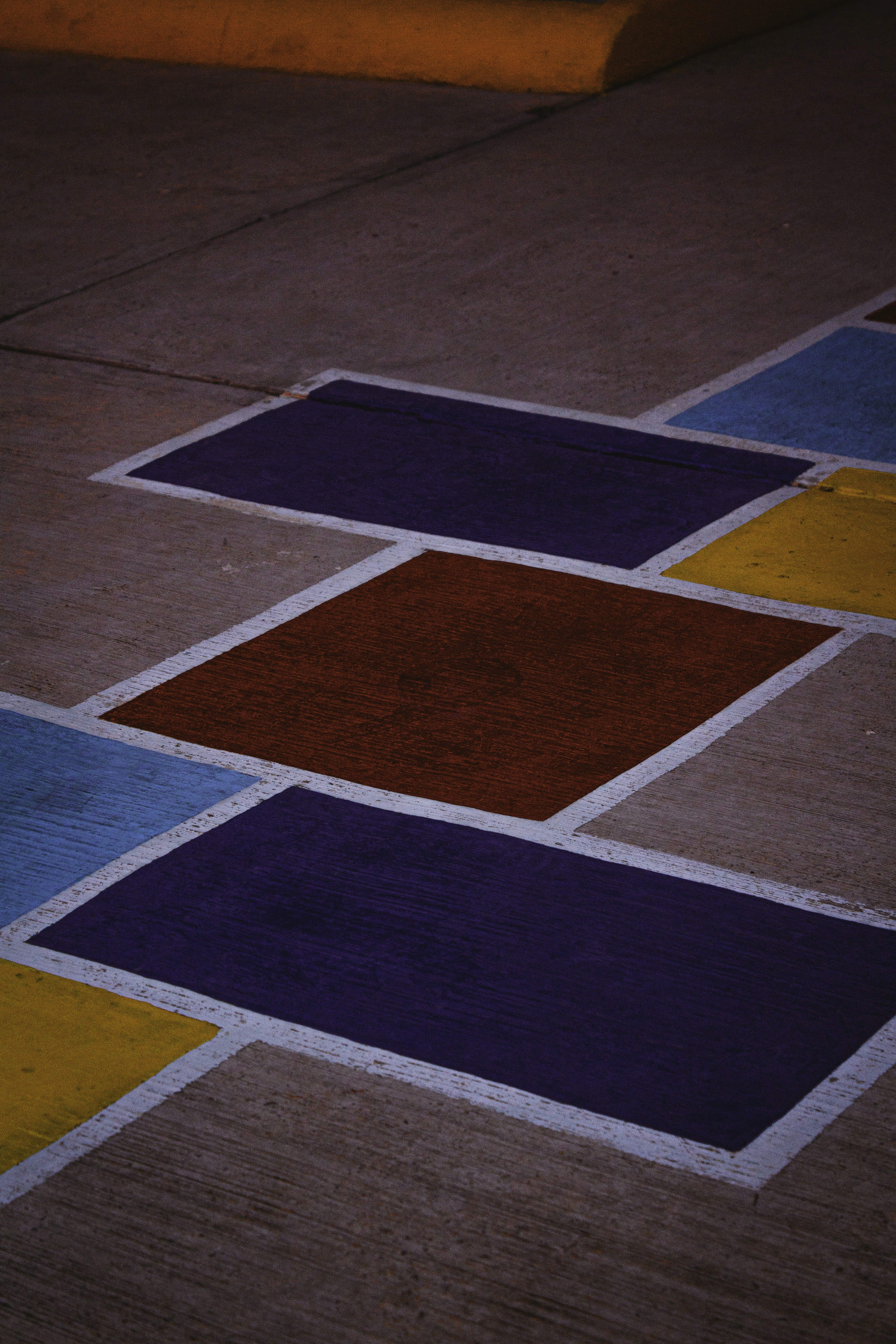 Diagonal Patchwork Beneath Streetlight: Squares of Color on Concrete