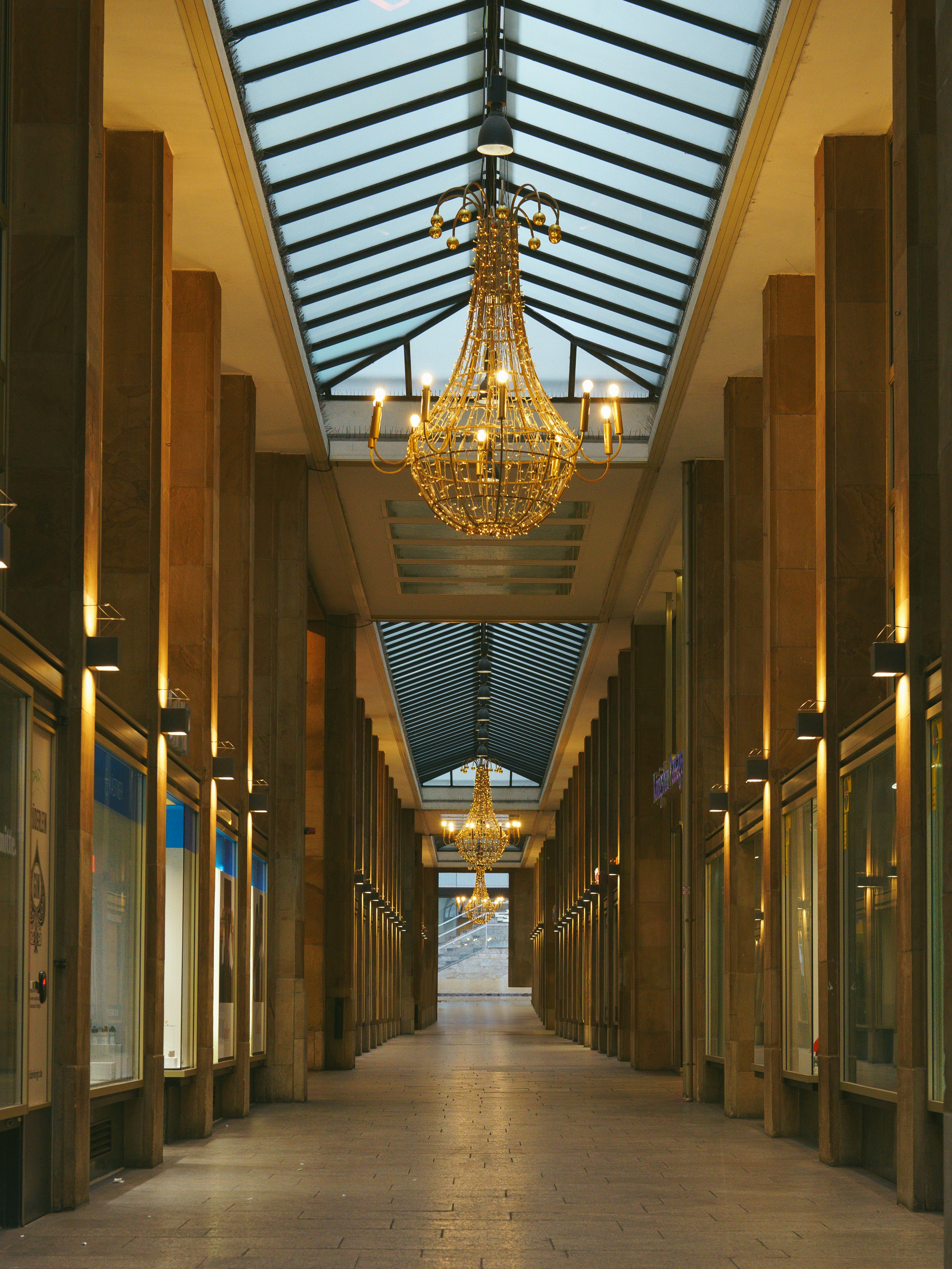 Symmetry Under Glass: Golden Orbs Hanging in a Long Corridor
