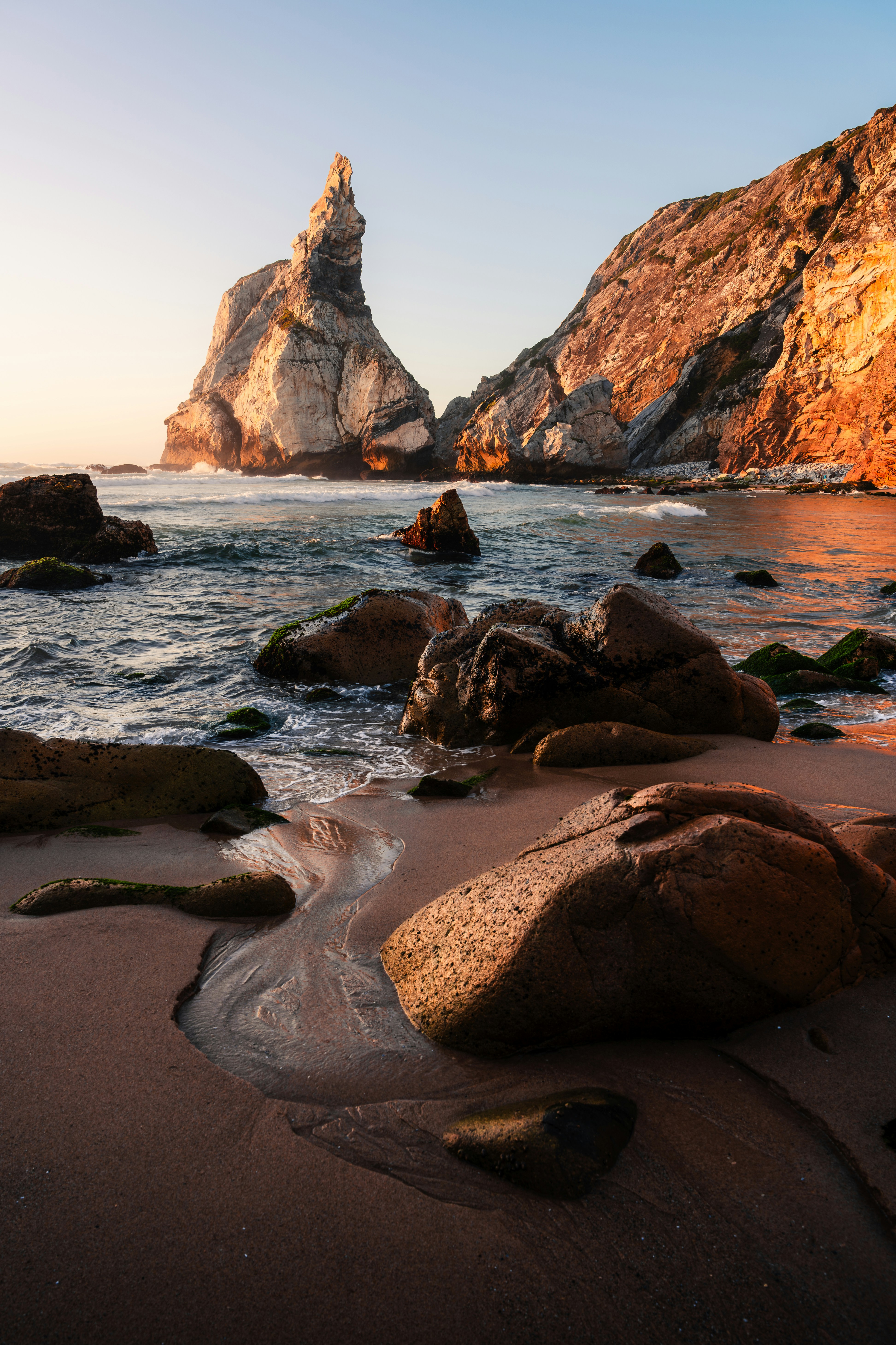 A beach with rocks and a body of water photo – Free Nature Image on ...