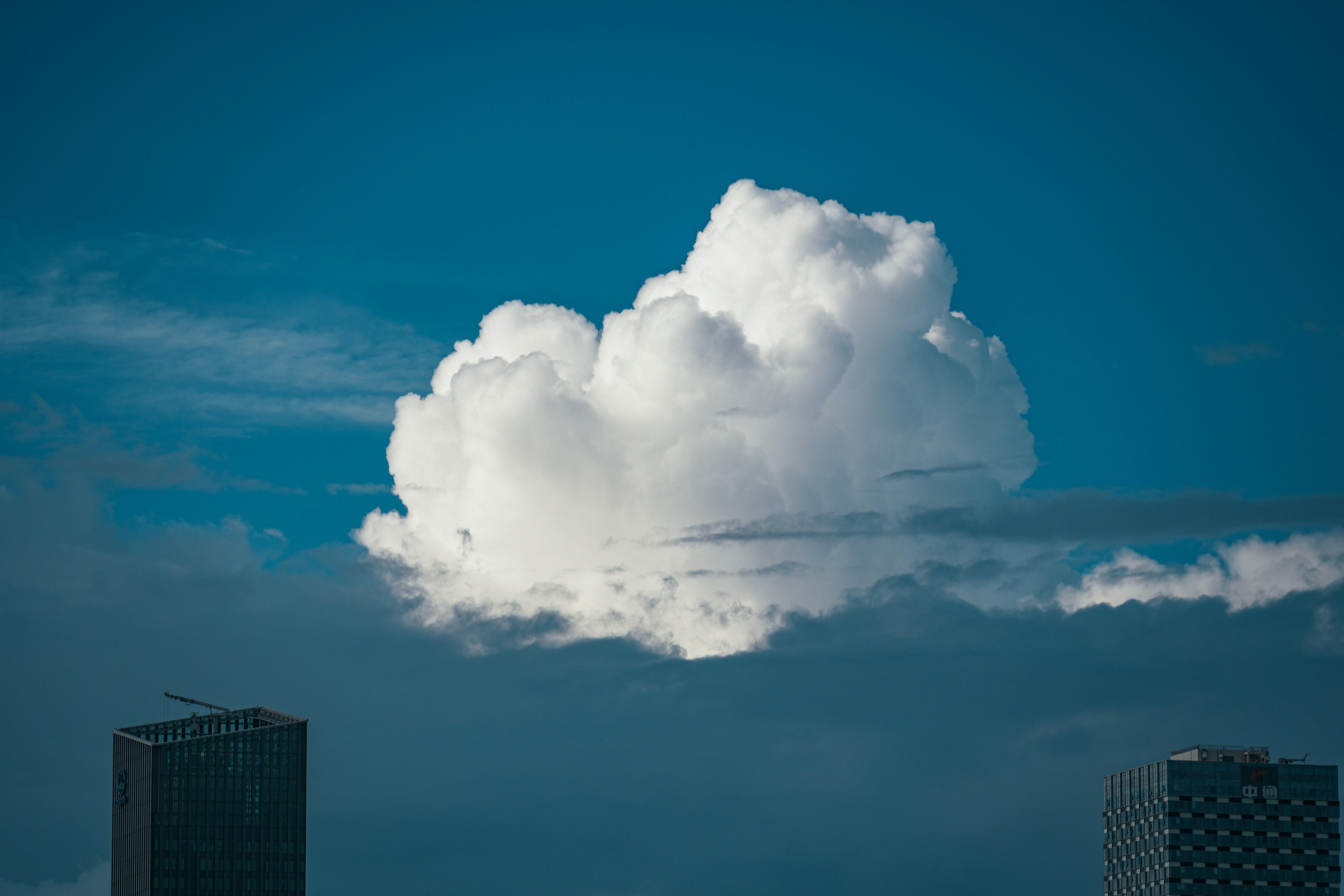 A cloud is in the sky over a city photo – Free Cloud Image on Unsplash