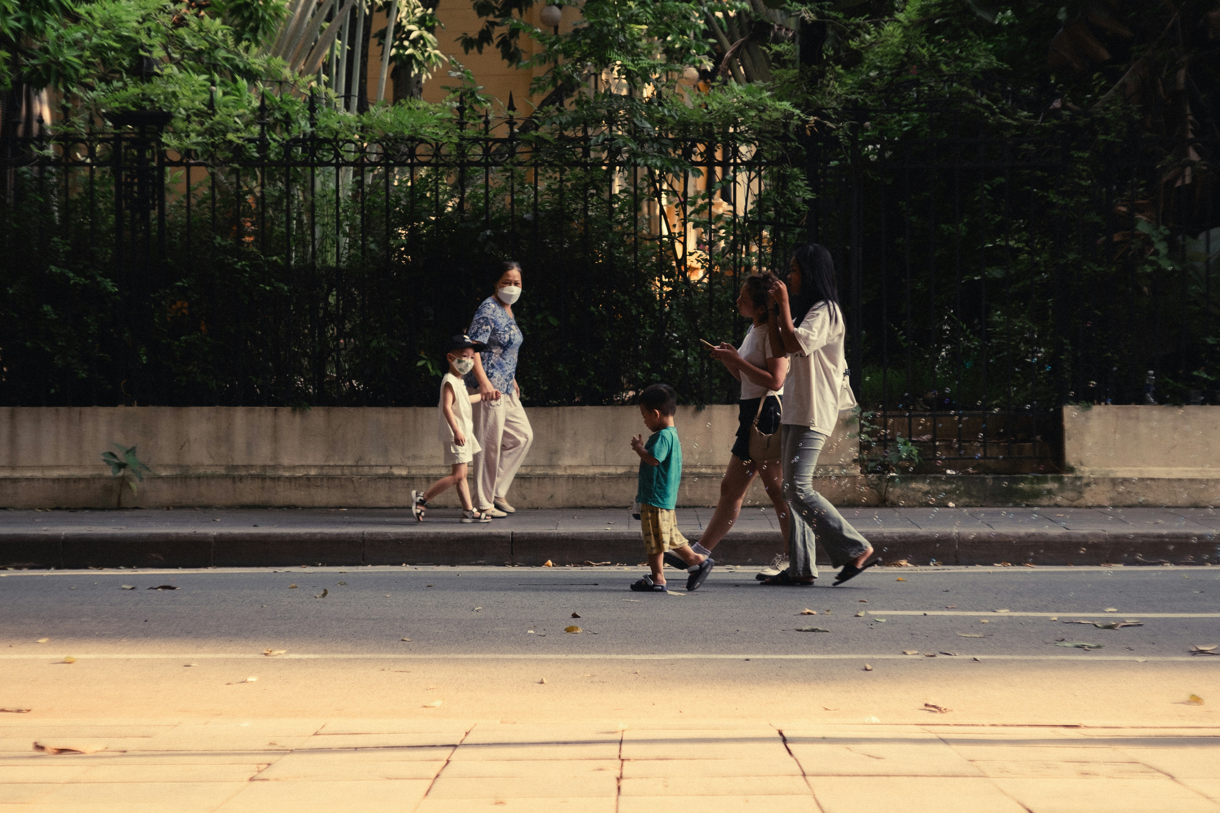 A group of people walking down a street